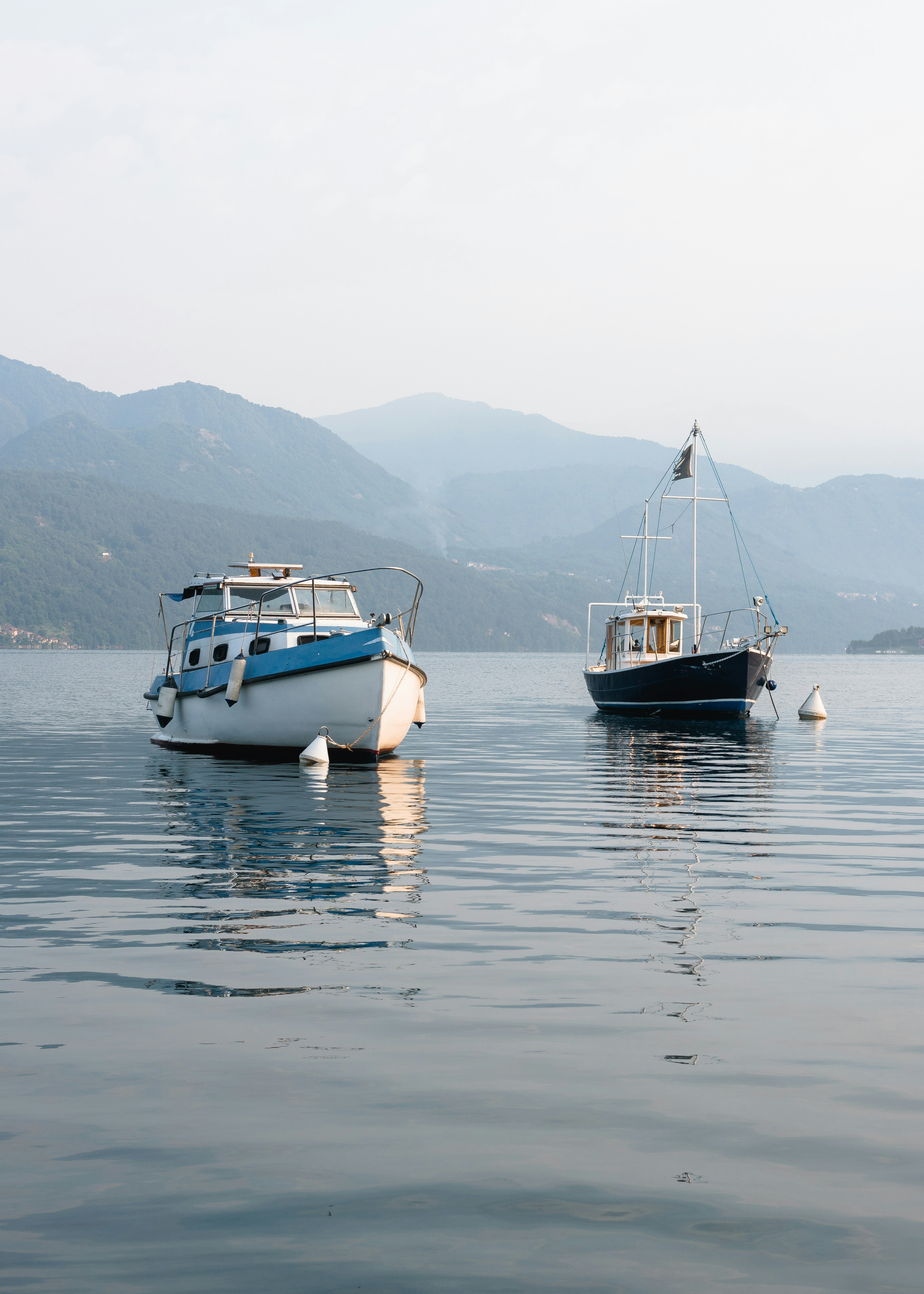 Boats on Lago d’Orta, Italy | white and blue powerboat ahead
