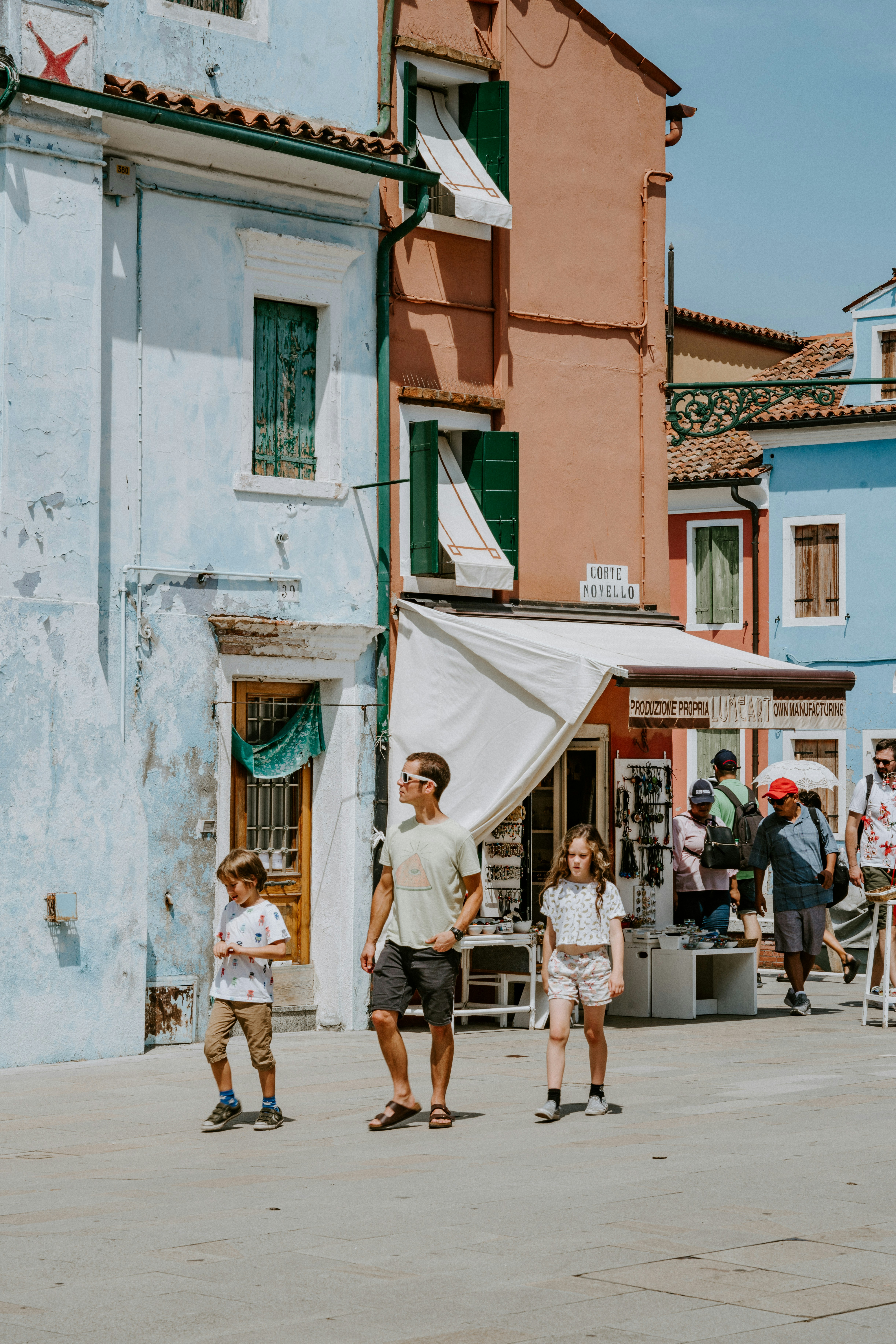 Pastel Street Shuffle: A Sunlit Walk Through a Colorful Coastal Town