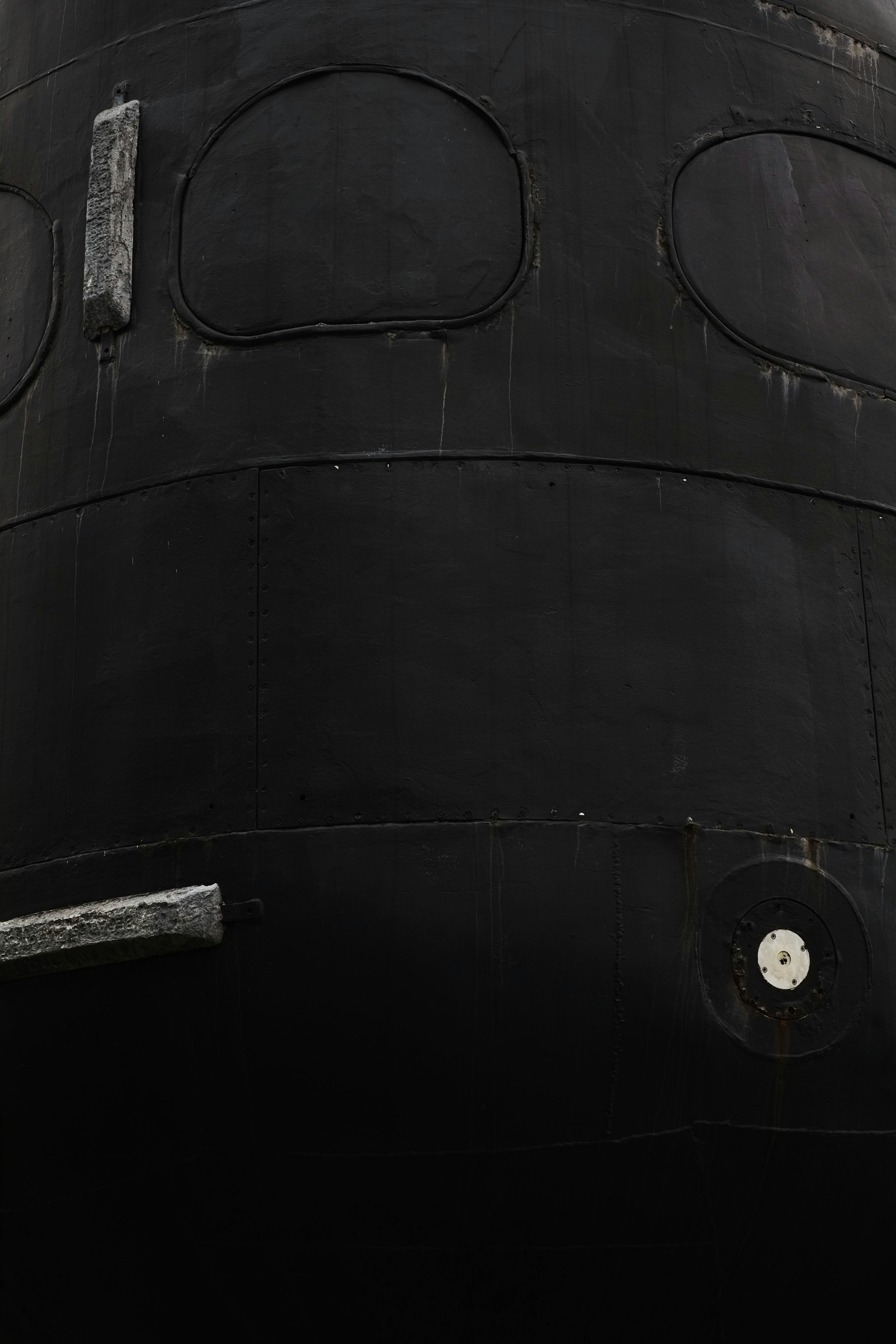 A close up of the side of a large black object photo – Free Black Image ...