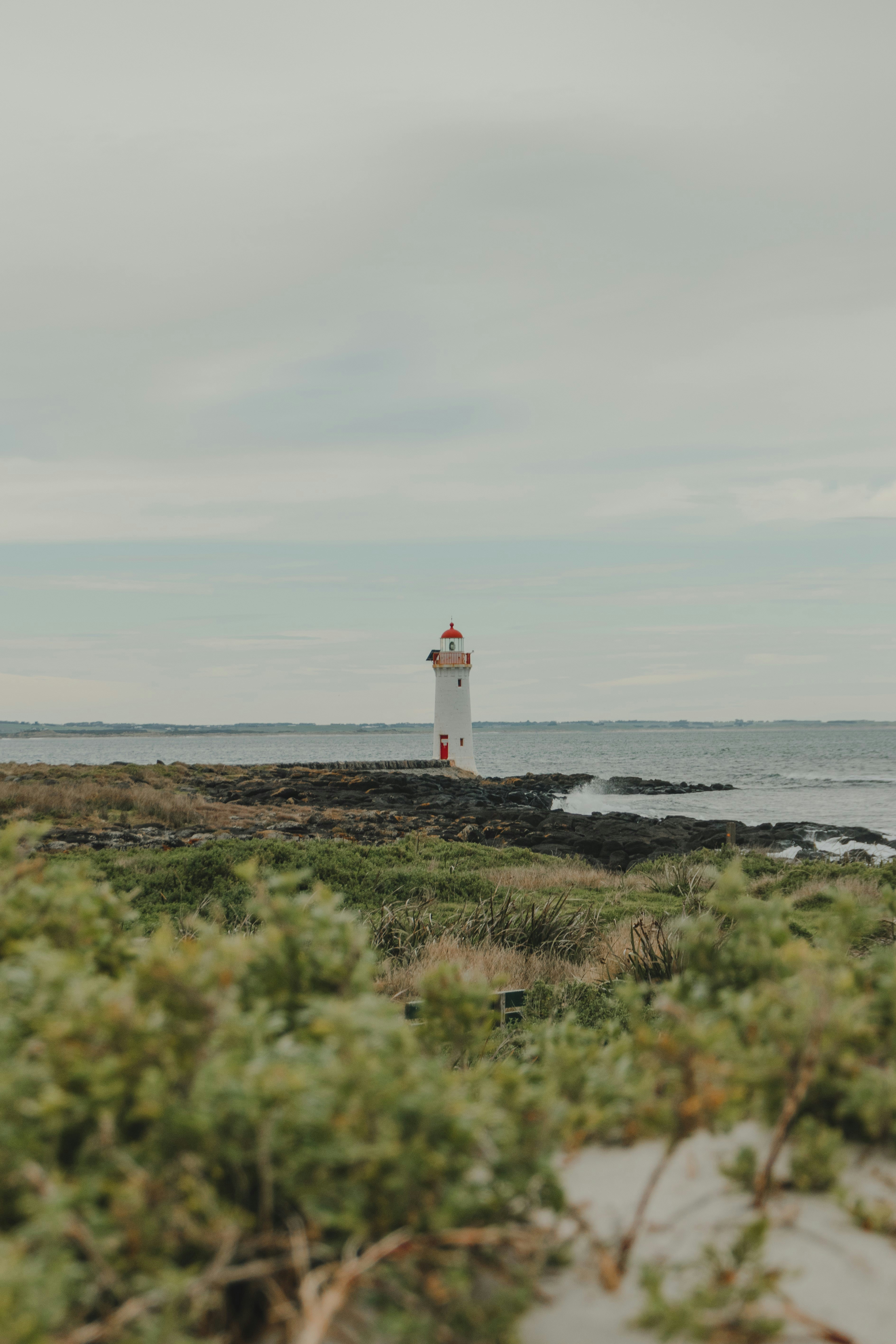 White lighthouse near sea during daytime photo – Free Wallpaper Image ...