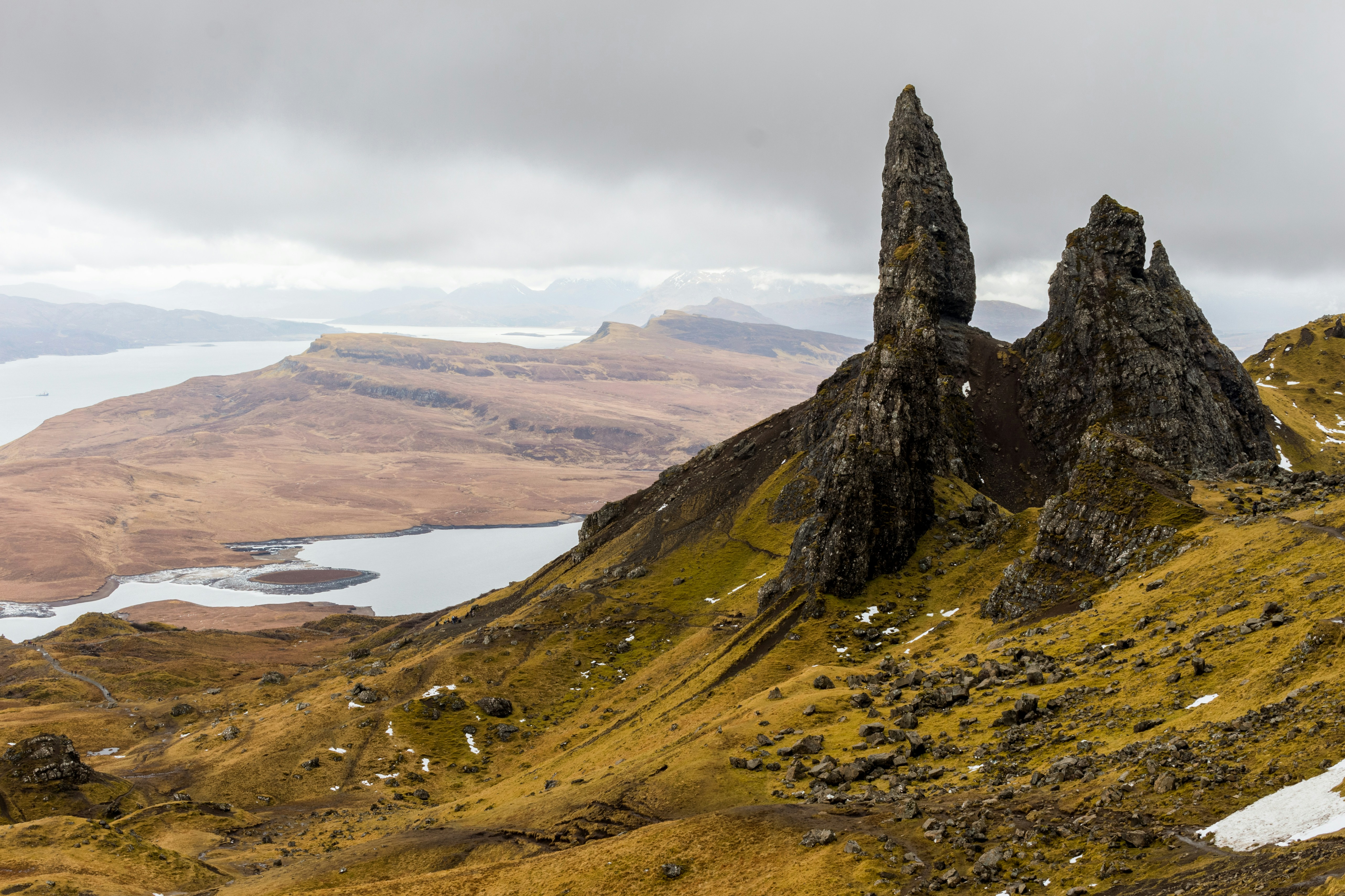 We decided to take the long way, to end our days hike at the Old Man of Storr. On top of the mountain we got caught in heavy rain and wind. Thankfully my camera stayed dry. After a 5 hour hike I captured this beautiful scene. It didn’t even bother me that there was almost no light. | black boulder surrounded by green grass