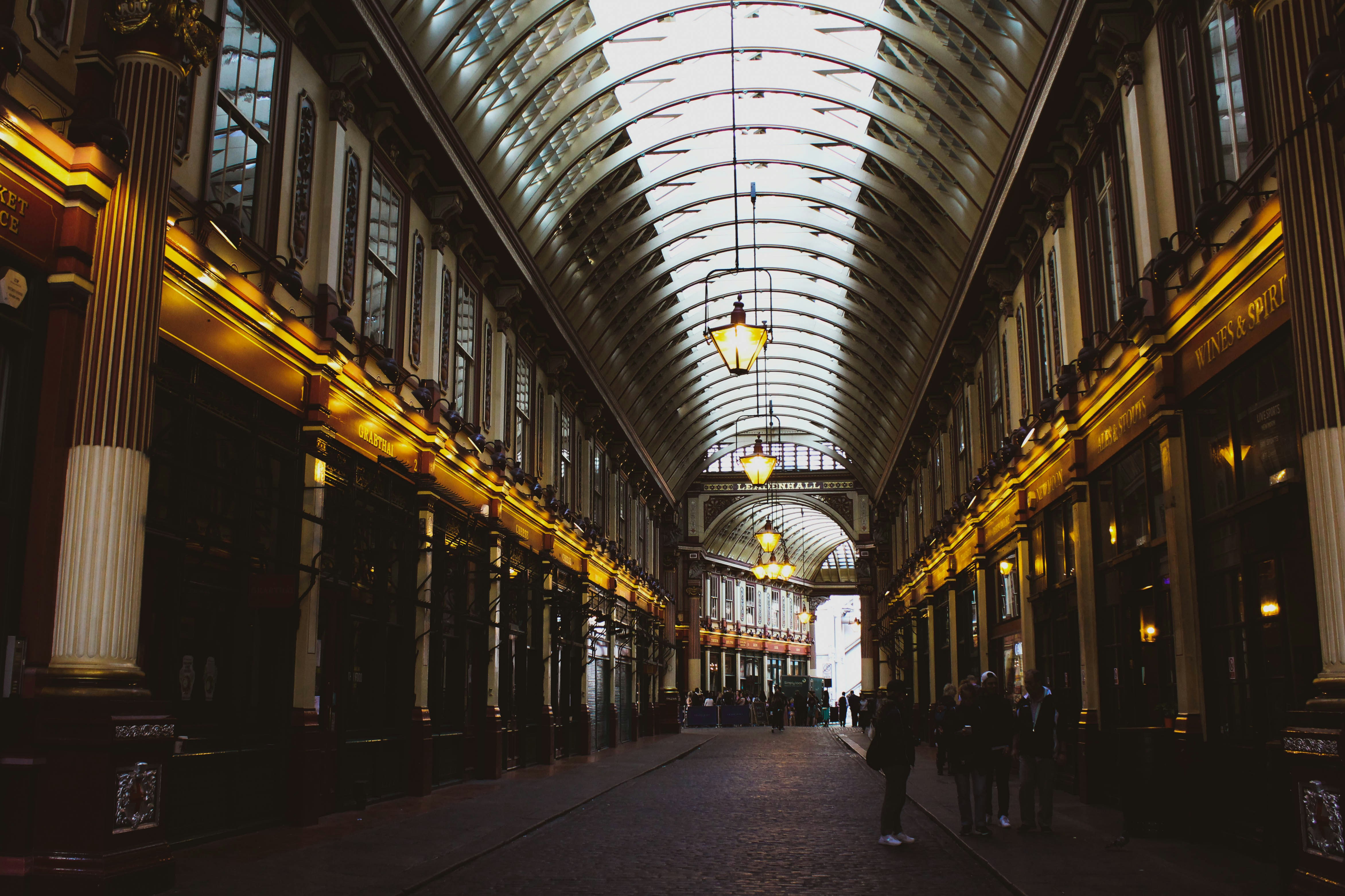 Historic shopping arcade featuring ornate architecture and warm lighting, inviting visitors to explore its shops and cafes.