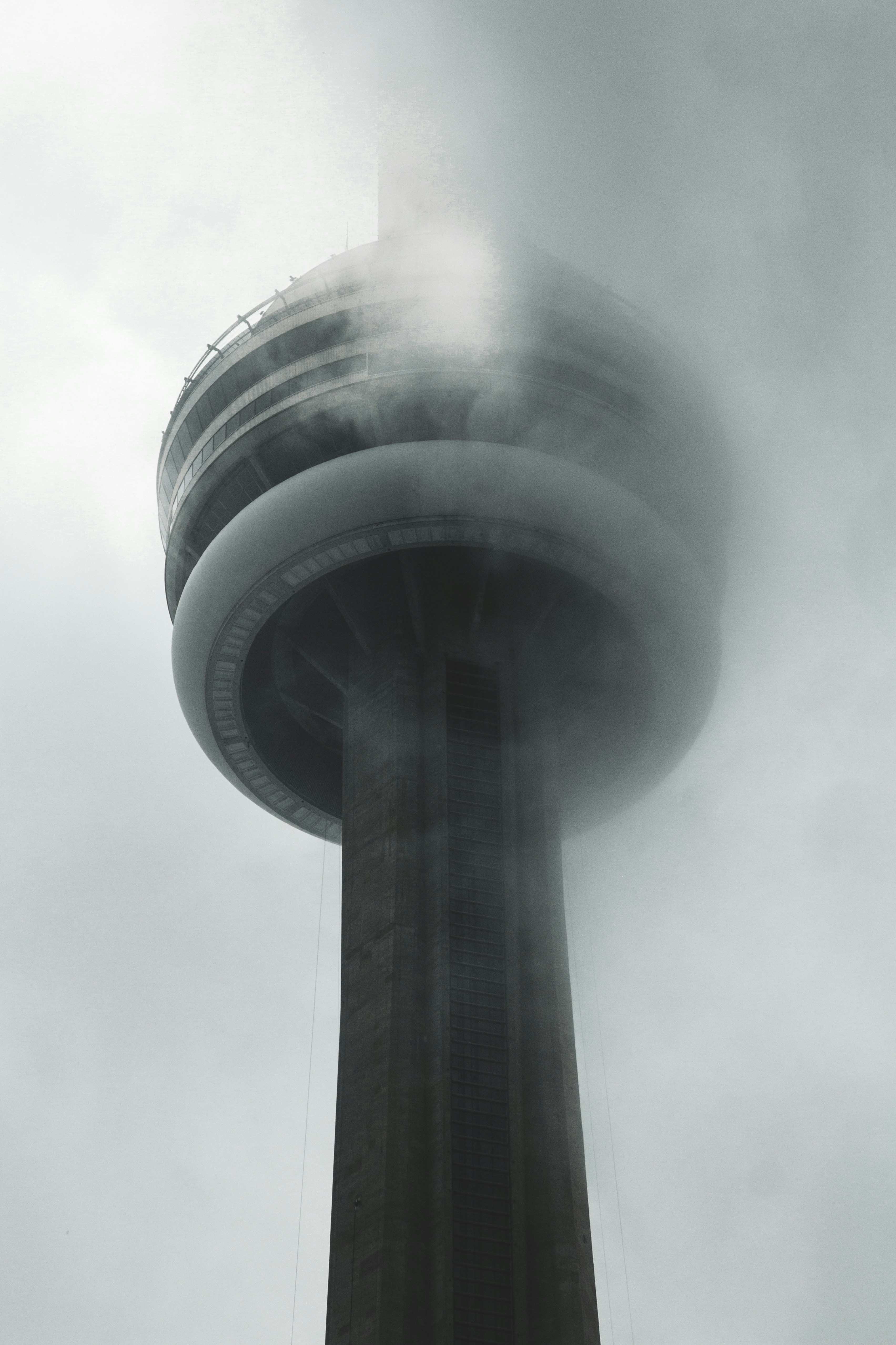 Ringed in Mist: The CN Tower Emerges Through Morning Fog