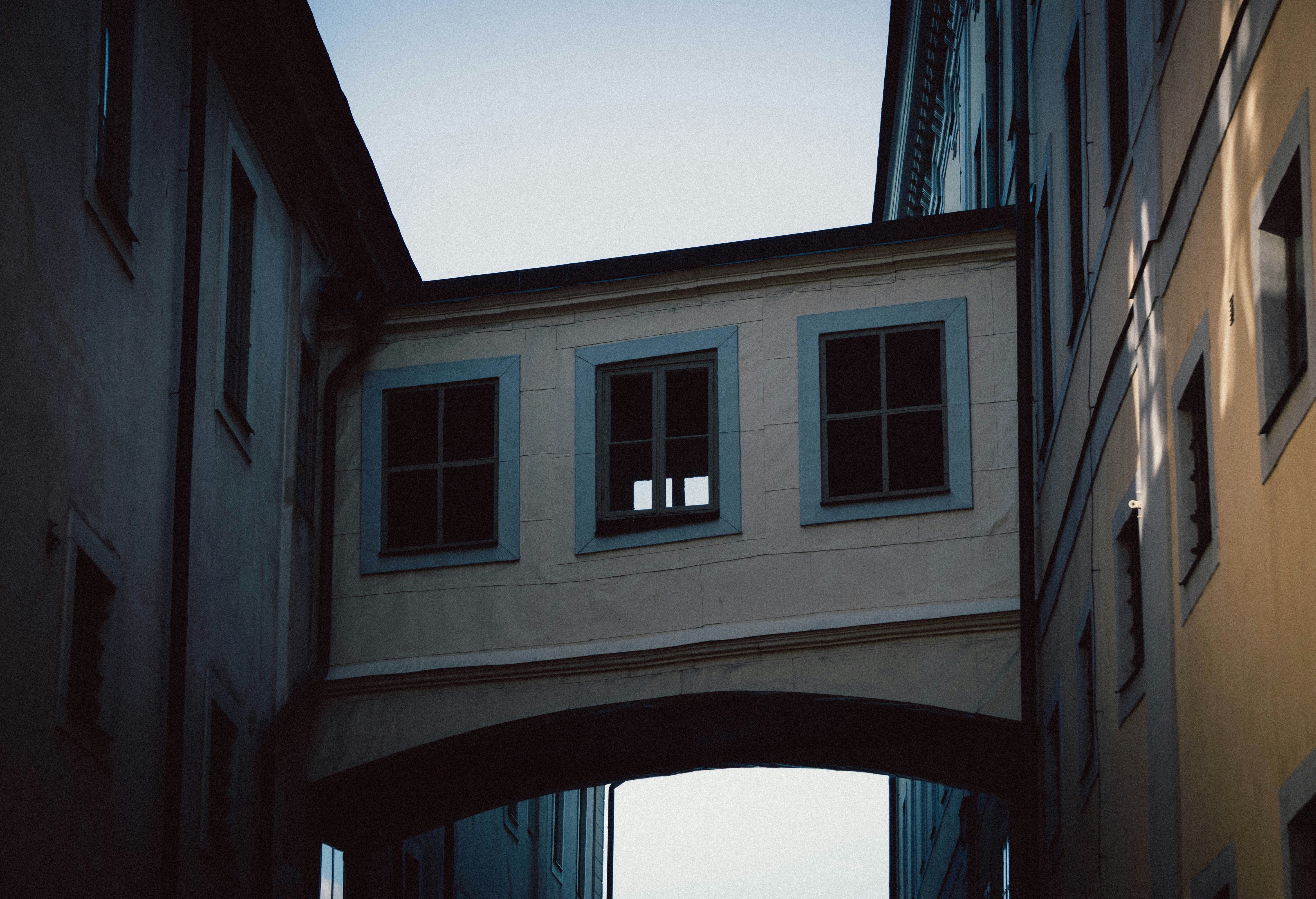 Archway at Dusk: A Narrow Passage Framed by Twin Facades