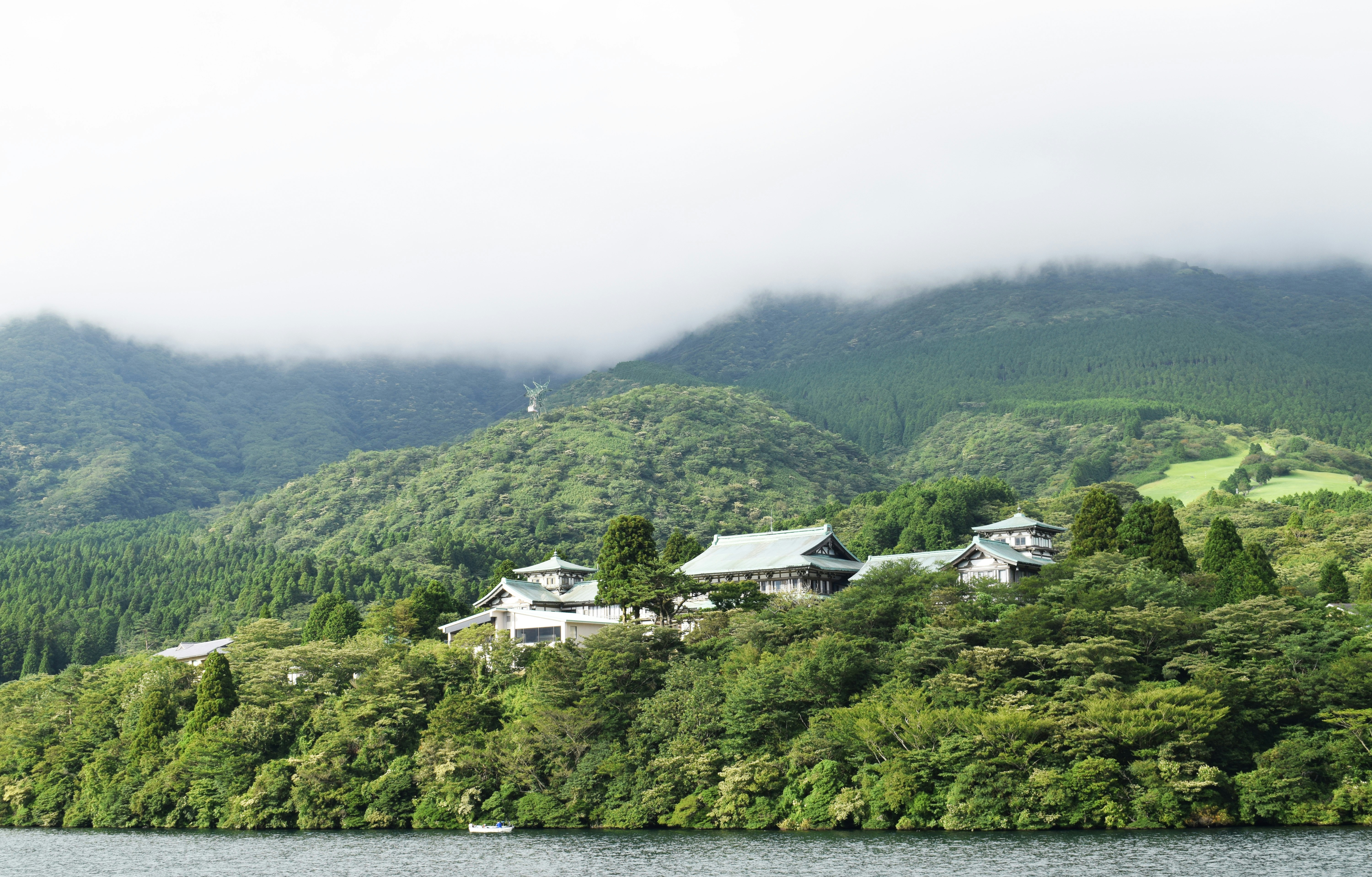 Hilltop Temples Beneath Morning Mist Over a Tranquil Lakeside