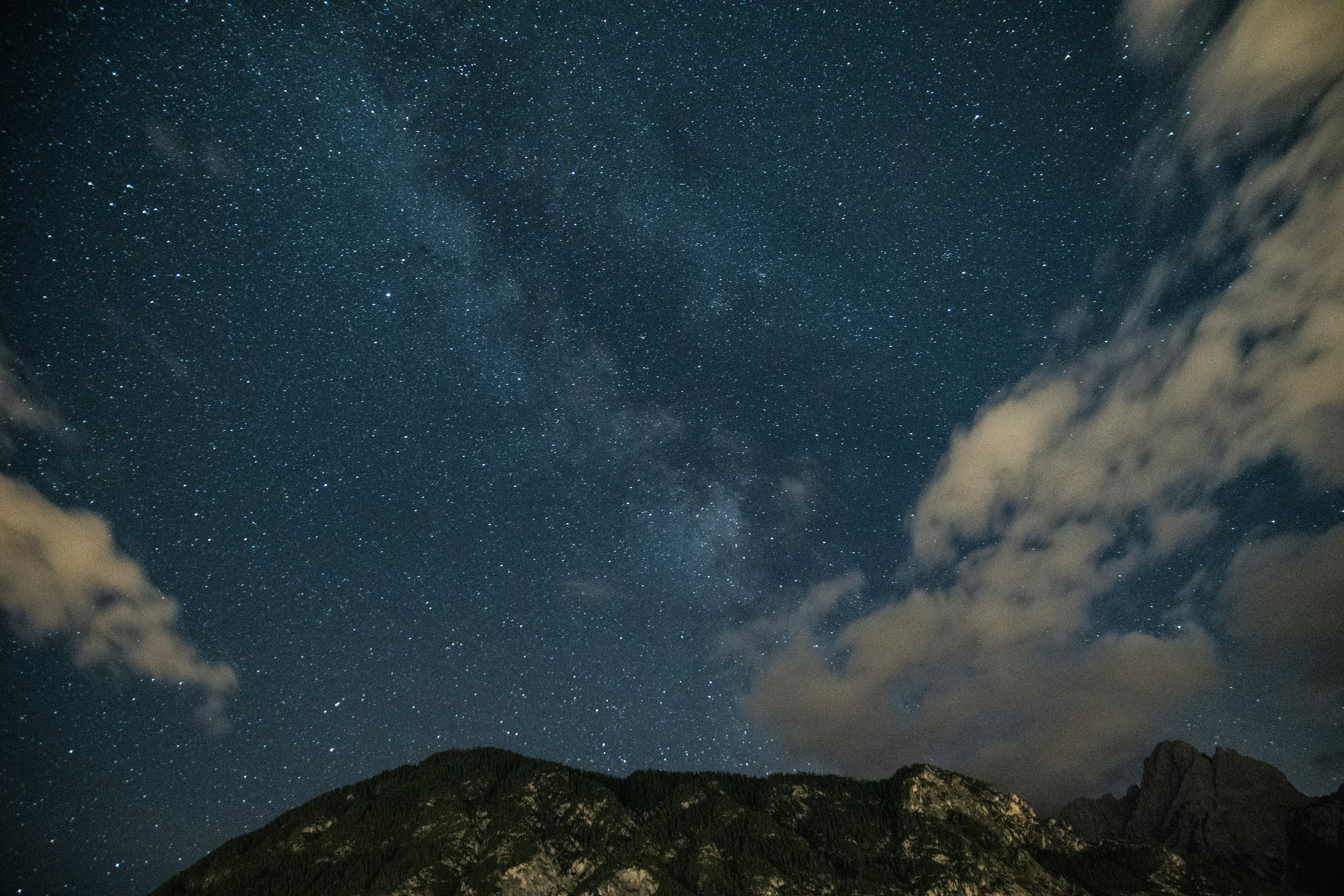 Celestial Canvas Over Mountain Silhouettes
