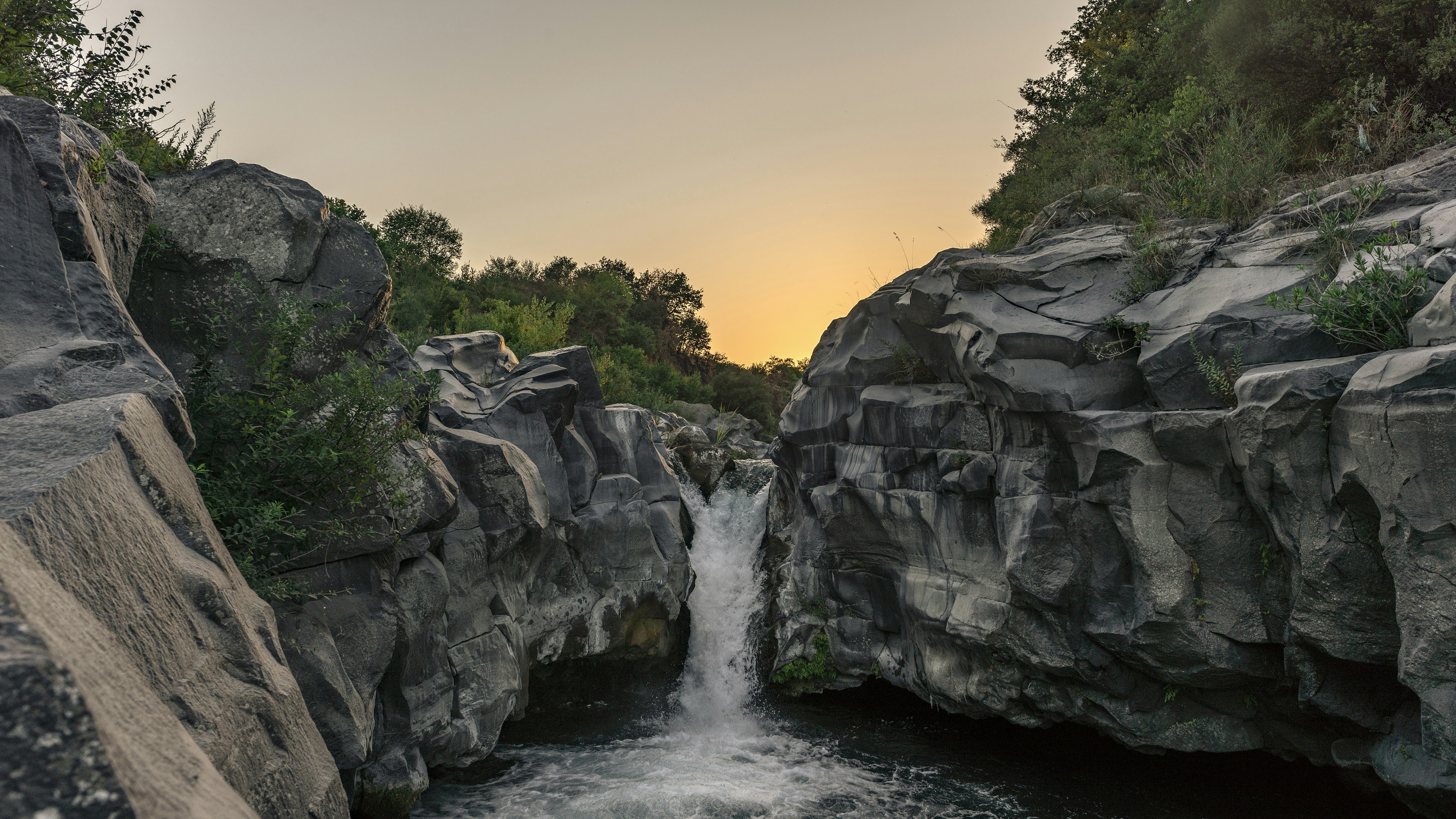 Canyon Cascade at Dusk: Light Threads Through Twin Granite Walls