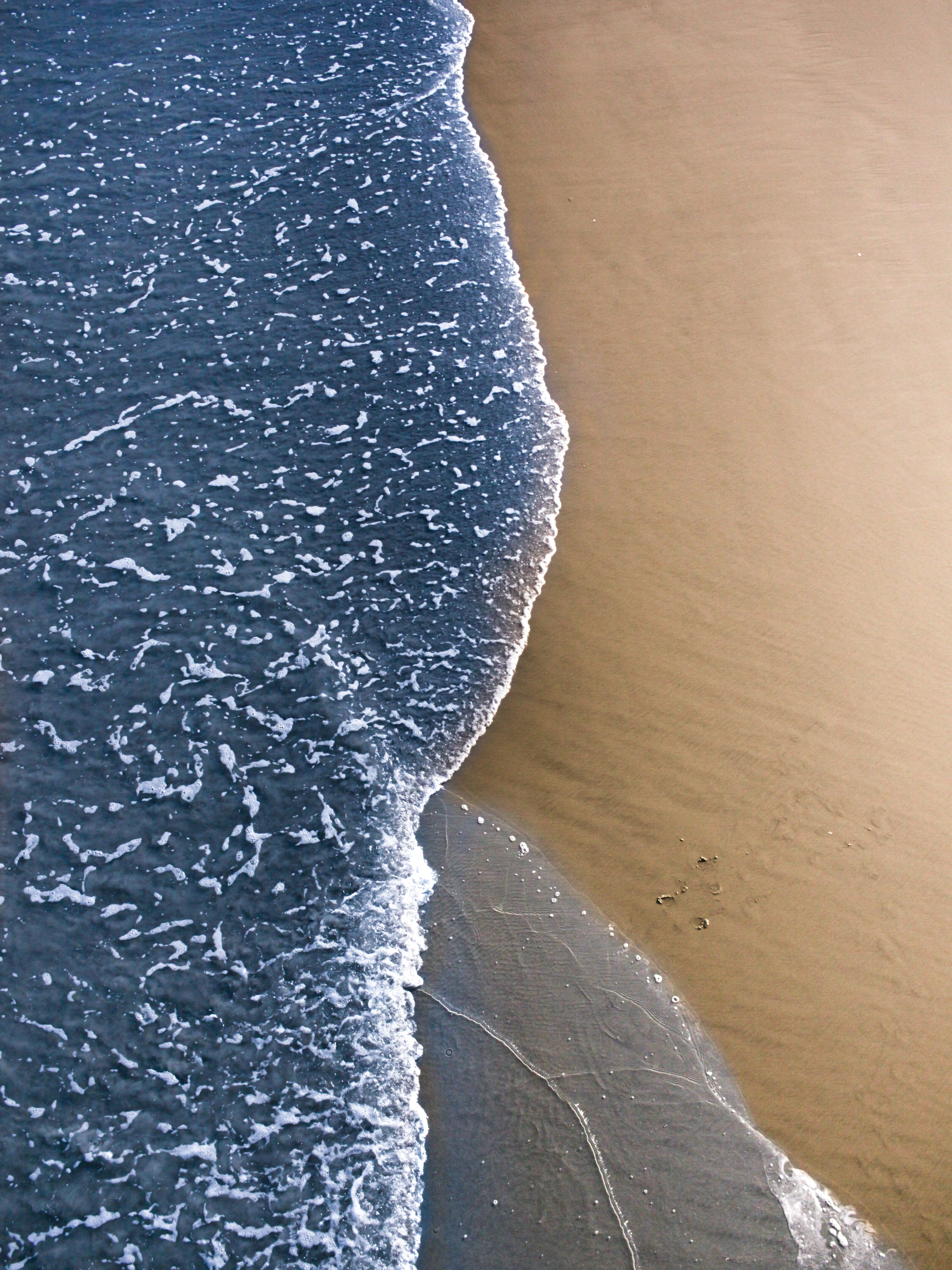 Tide's Gentle Embrace on Golden Sands
