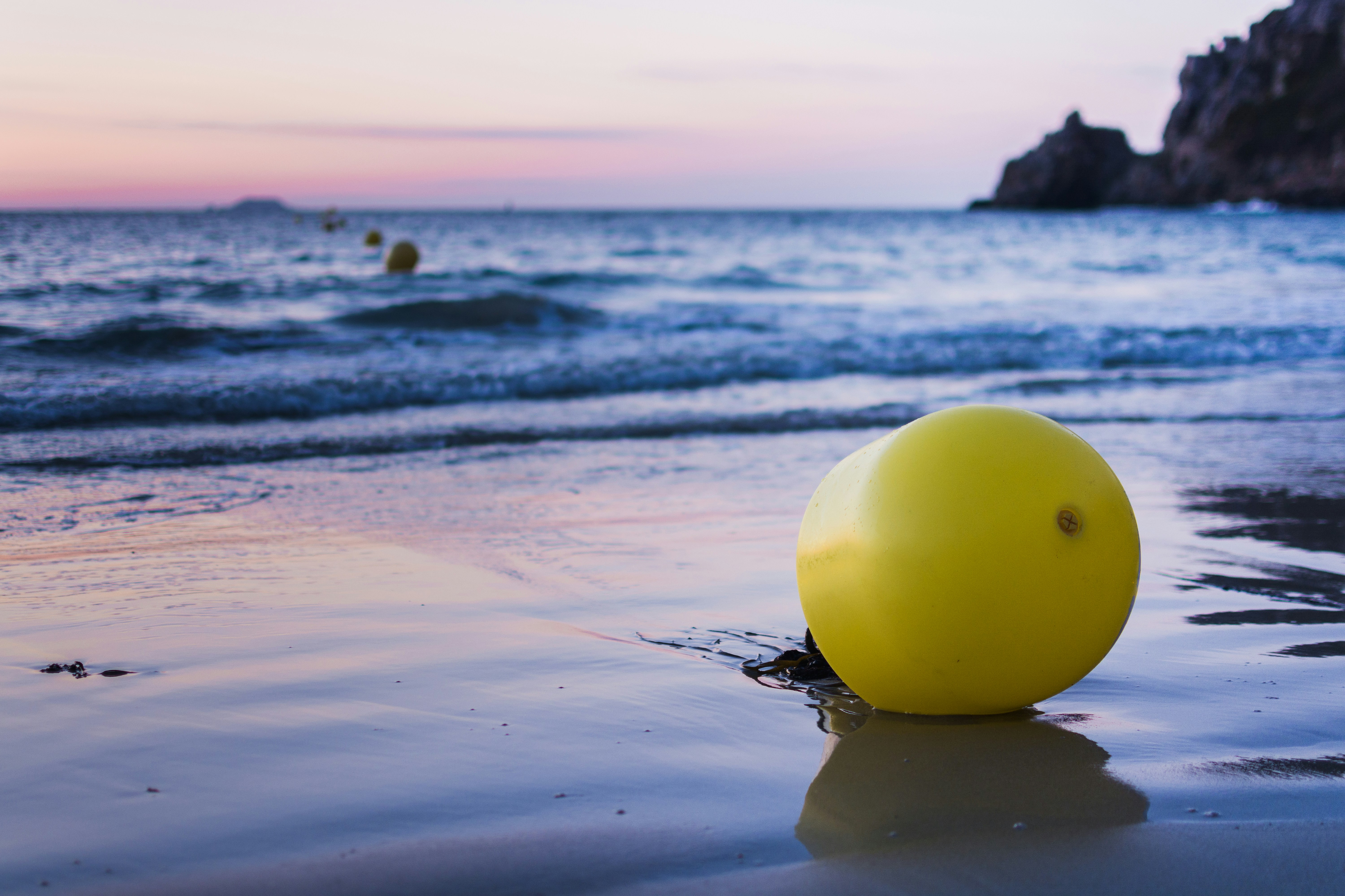 Glossy Yellow Buoy on Sunset Shore