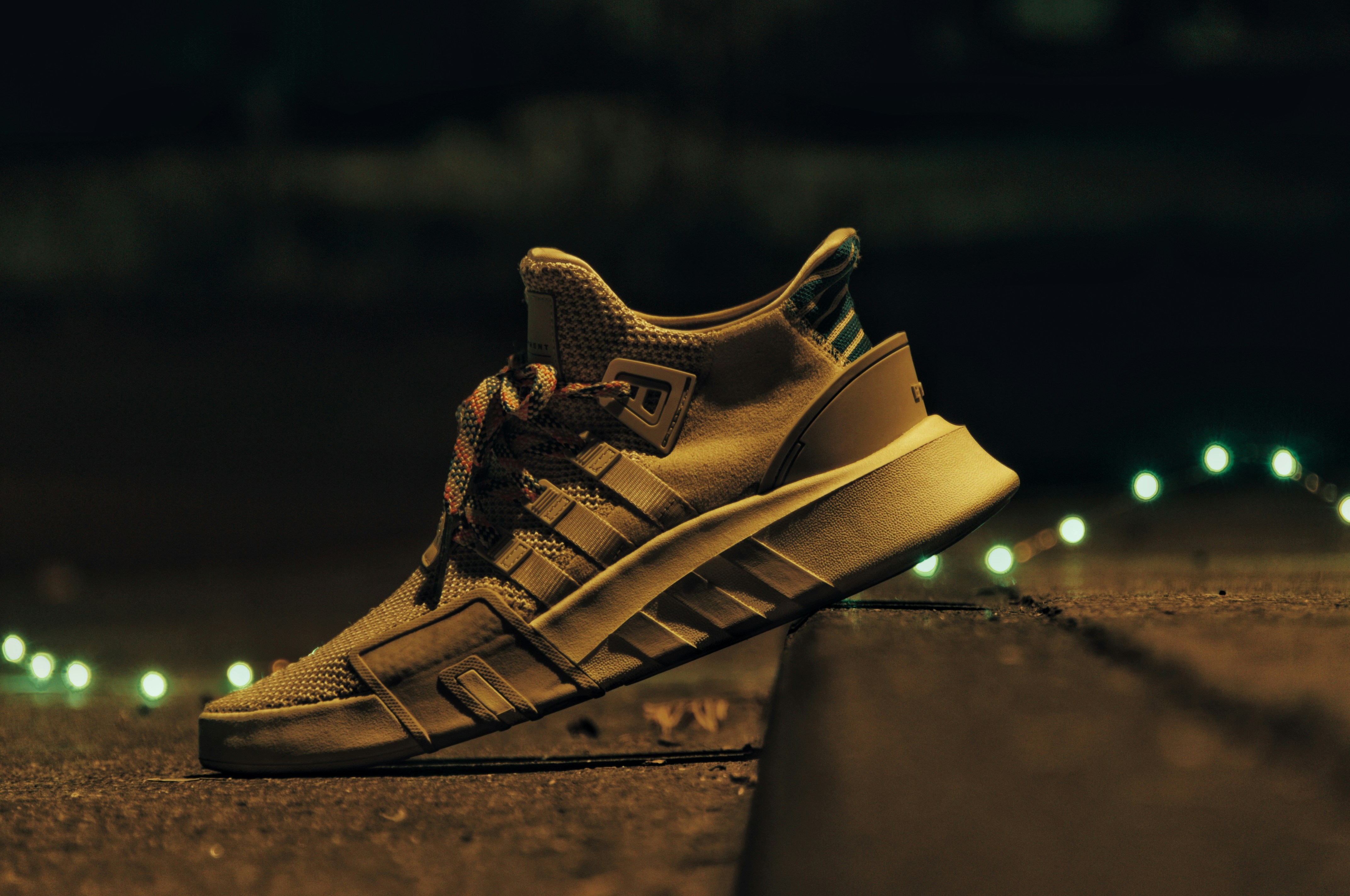 Was wating for a friedn to go out and shoot so i though i might aswell start taking pictures. So I took some fotos of my shoes | selective focus photo of brown adidas ultra BOOST sneaker on pavement at nighttime