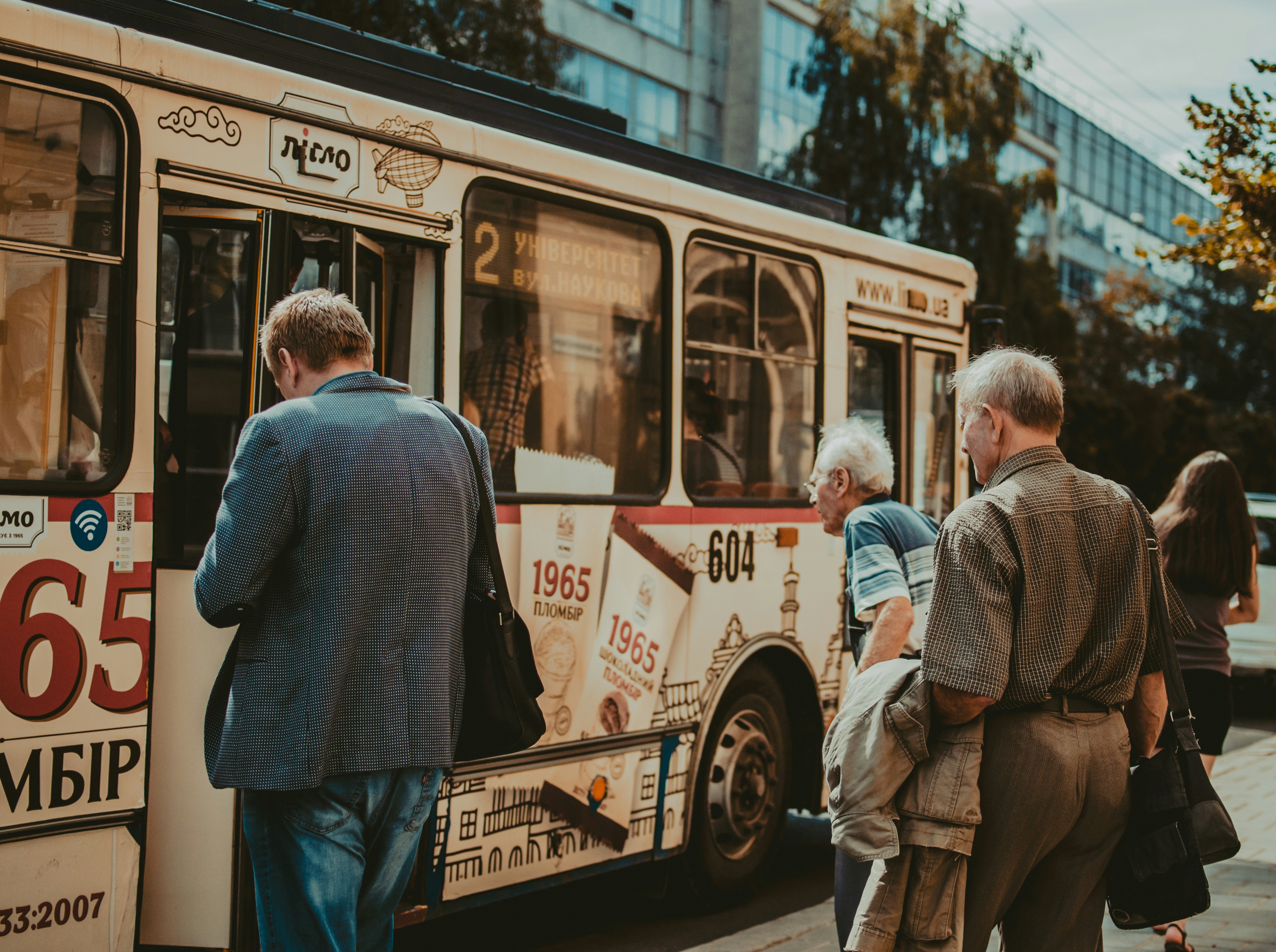 three men standing outside bus photo – Free Lviv Image on Unsplash
