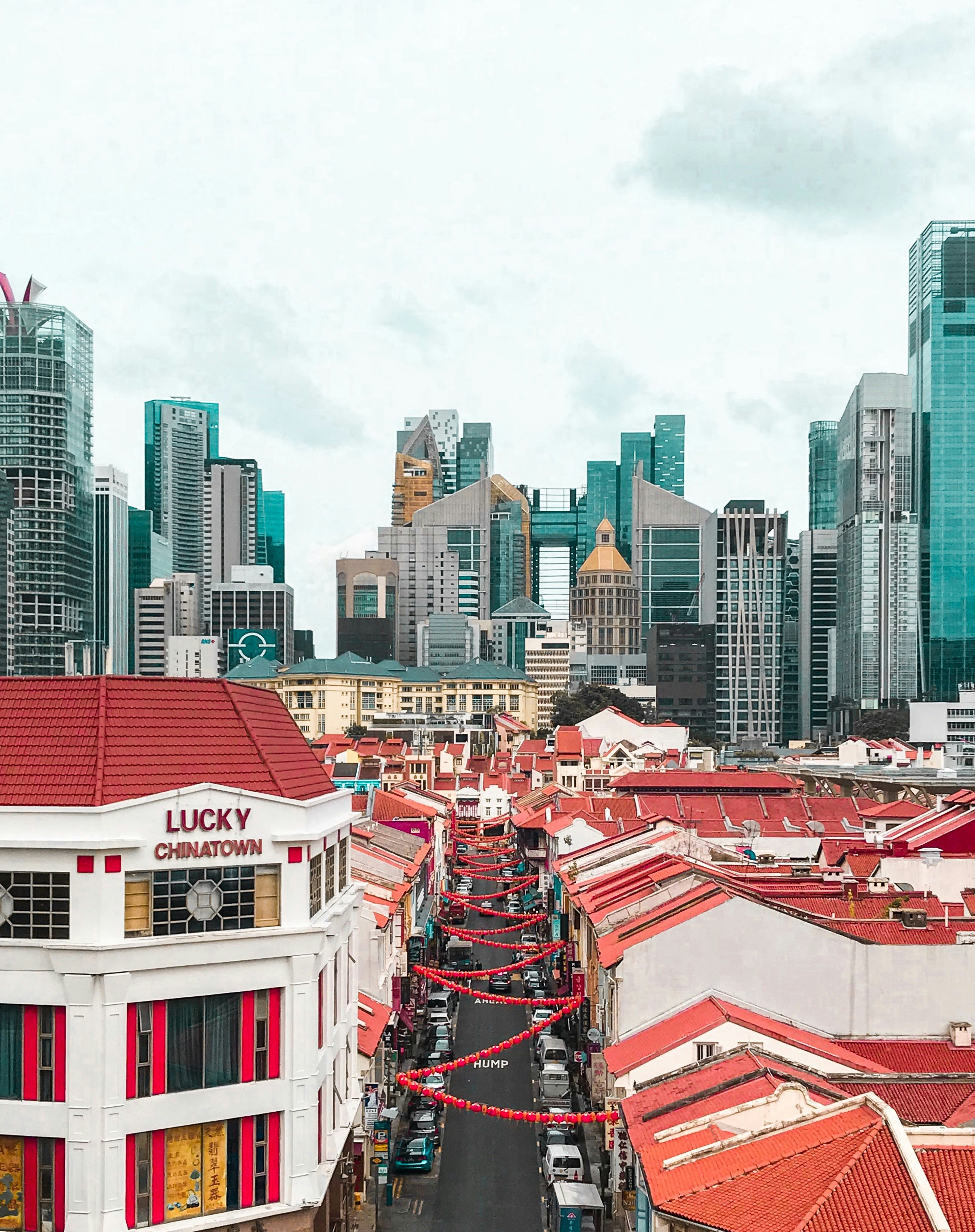 Chinatown's vibrant streets lined with traditional shophouses juxtaposed against a backdrop of towering skyscrapers, showcasing a blend of heritage and contemporary architecture.