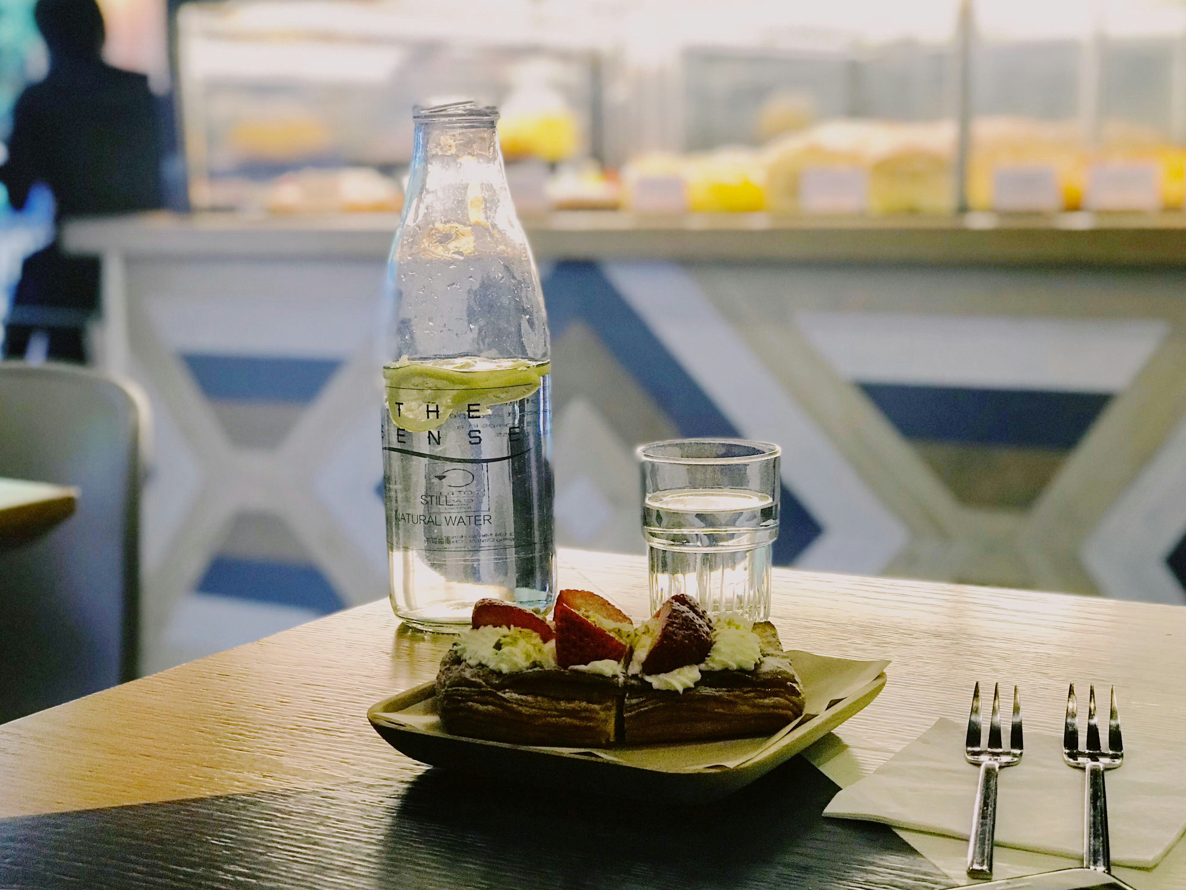 Lemon-infused Carafe and Cake on a Sunlit Table