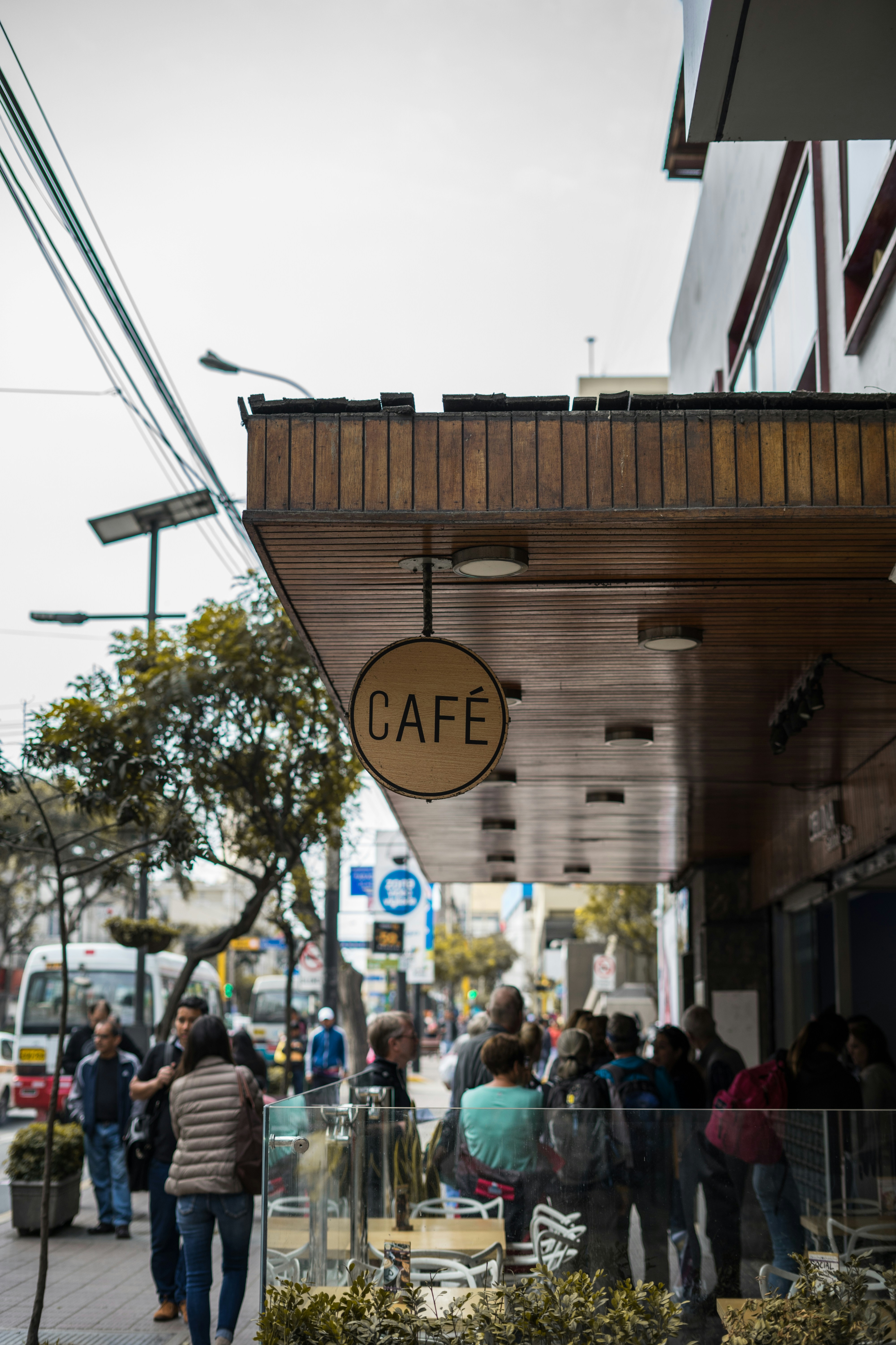 Cafe Sign in a Busy Street: A Slice of Urban Afternoon