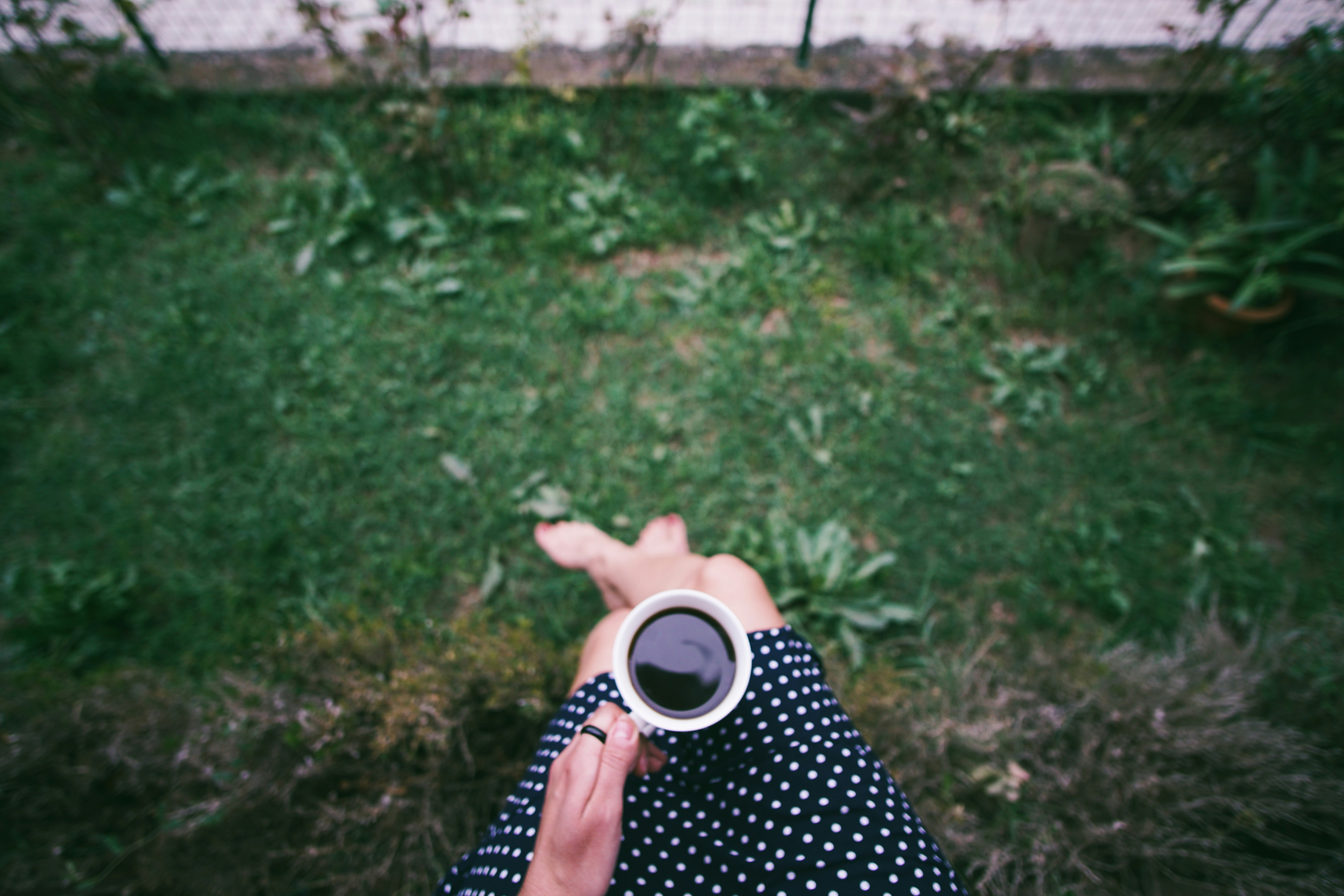 Top-Down Tranquility: A Polka-Dot Sleeve Cradles a Pale Mug