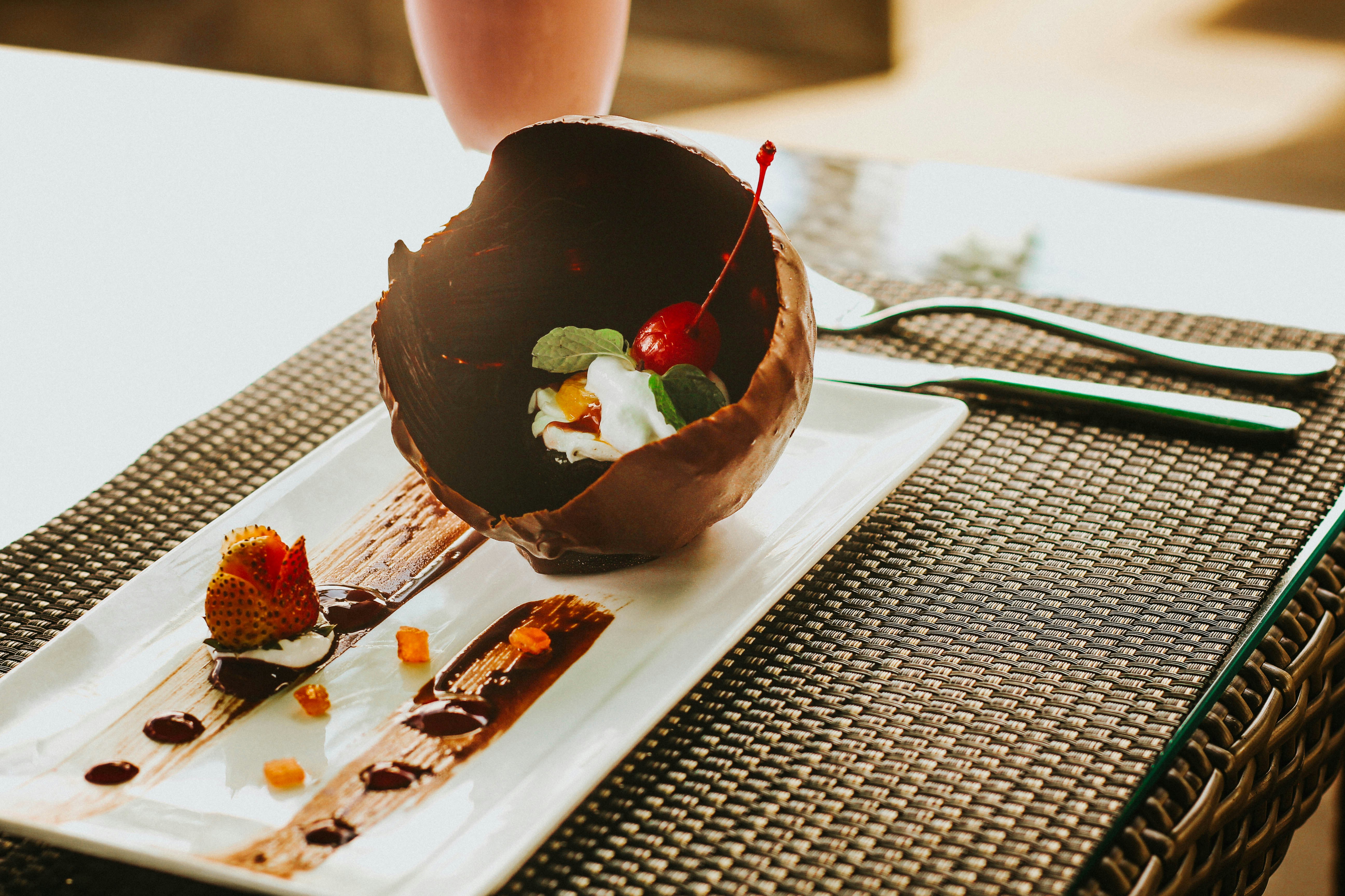 Chocolate Hemisphere Dessert with Garnish on a Long Plate