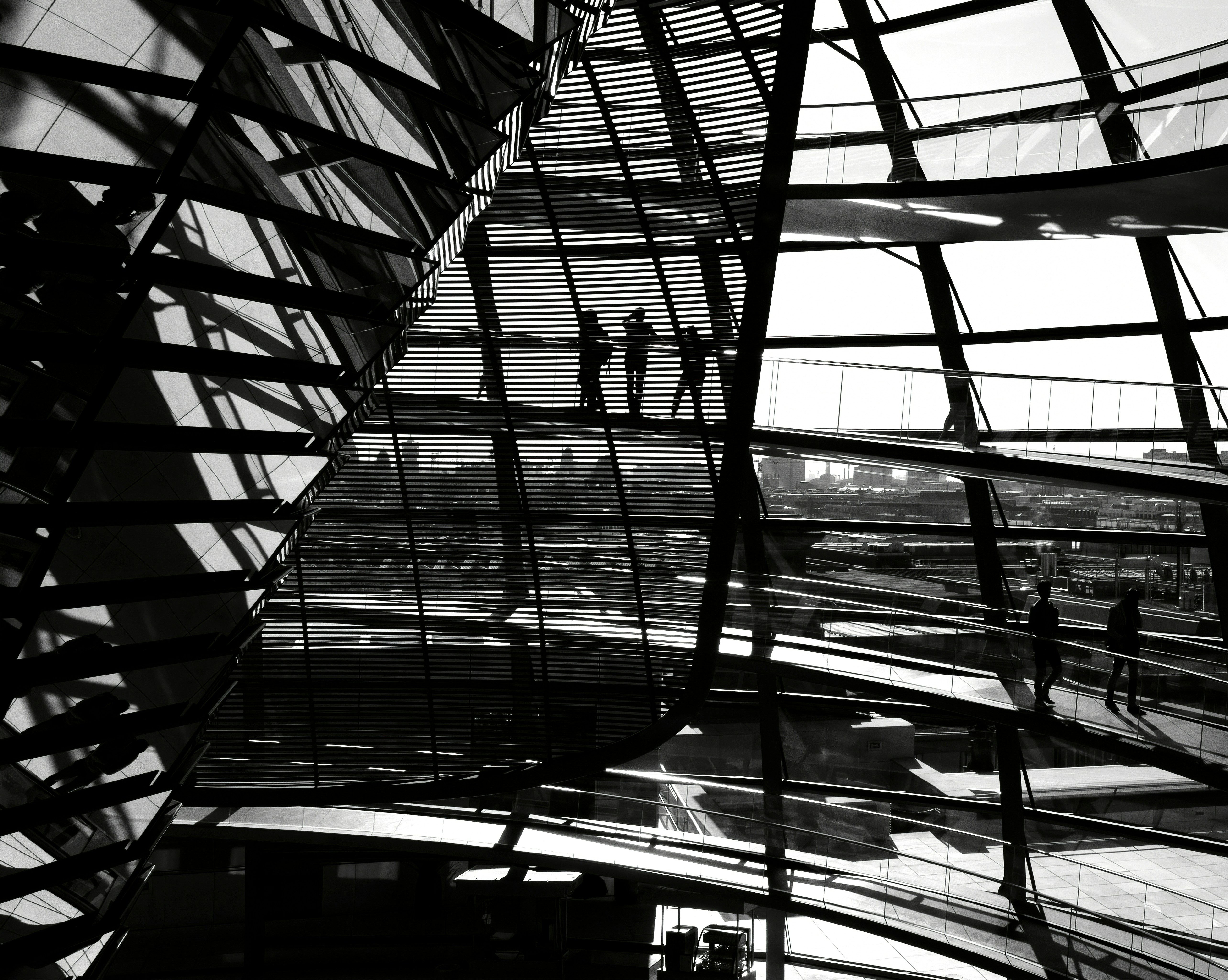 Grayscale photography of three people standing inside metal building ...