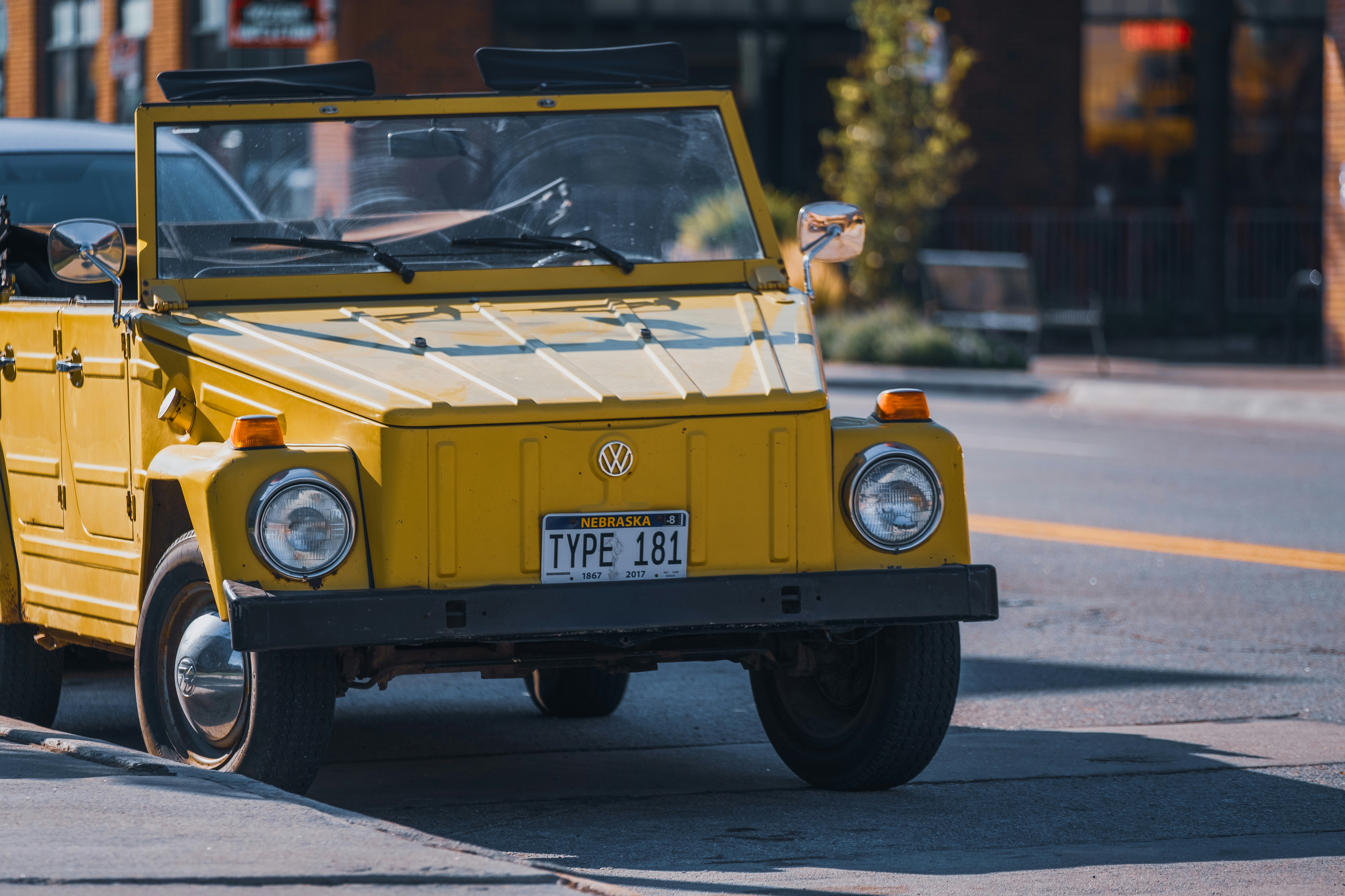Yellow VW Beetle on a Quiet Street: A Retro Convertible in Focus