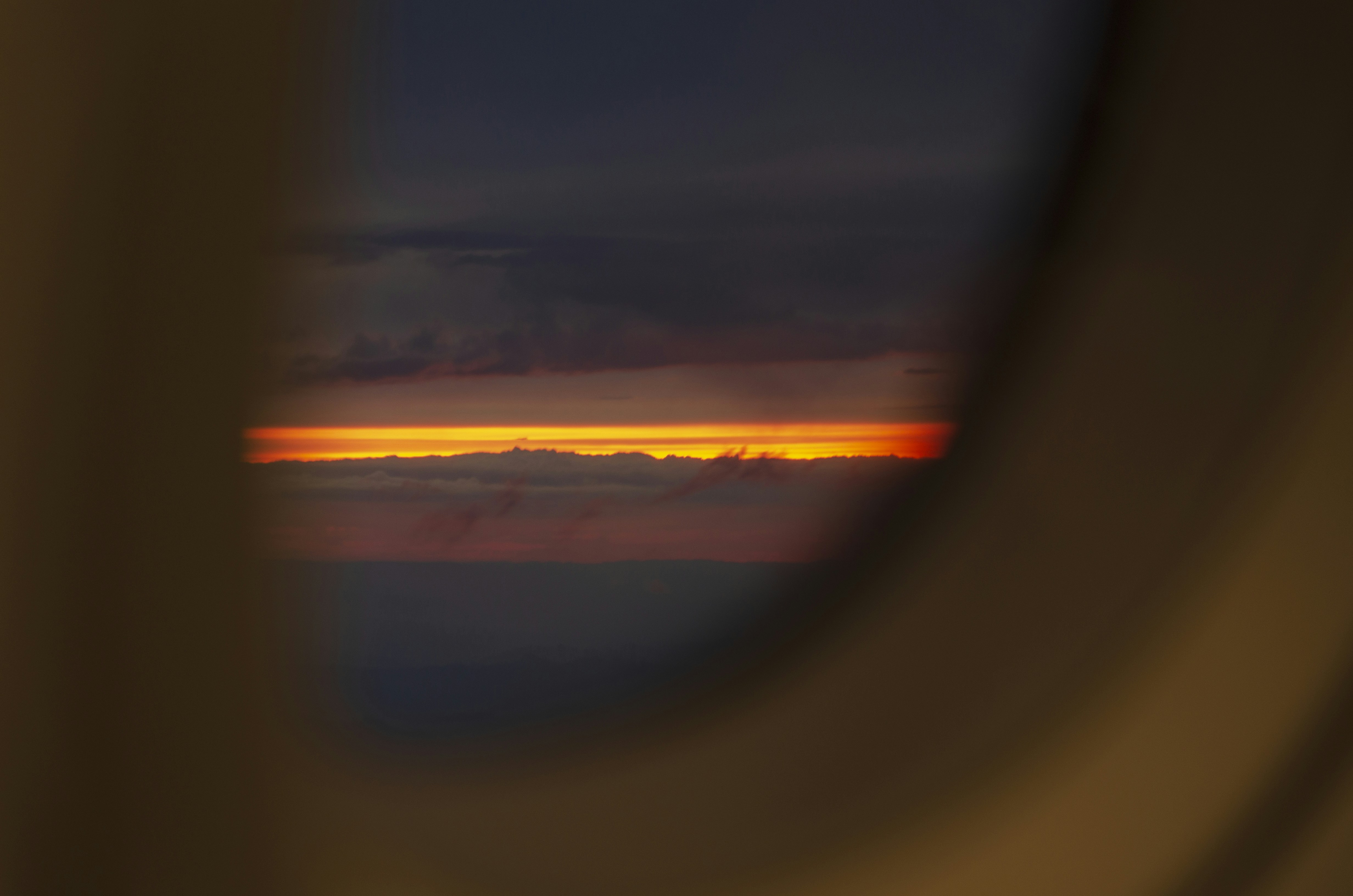 Sunset Through a Circular Frame: A Ringed Horizon