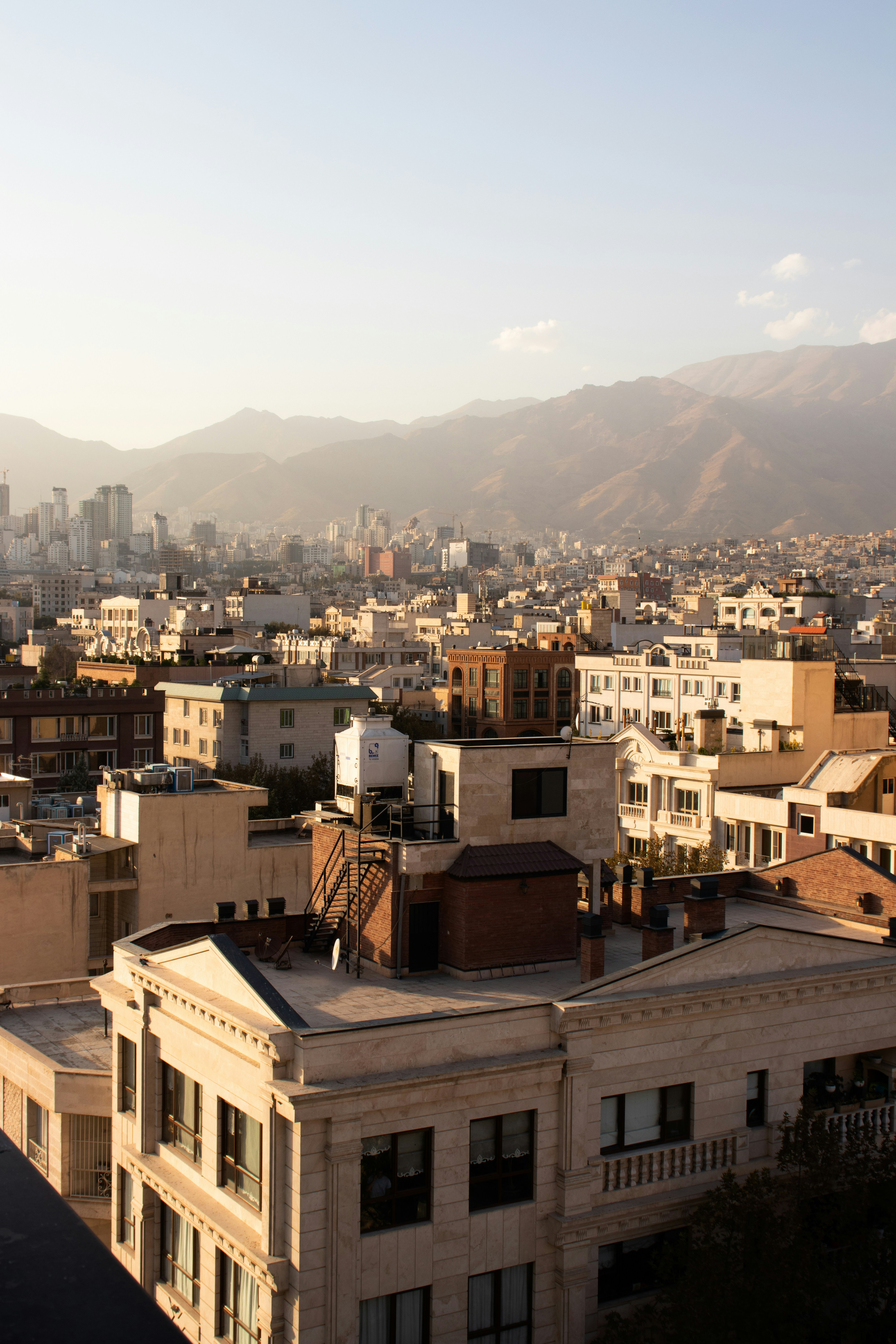 Sunset Over a Terraced Cityscape with Mountain Backdrop