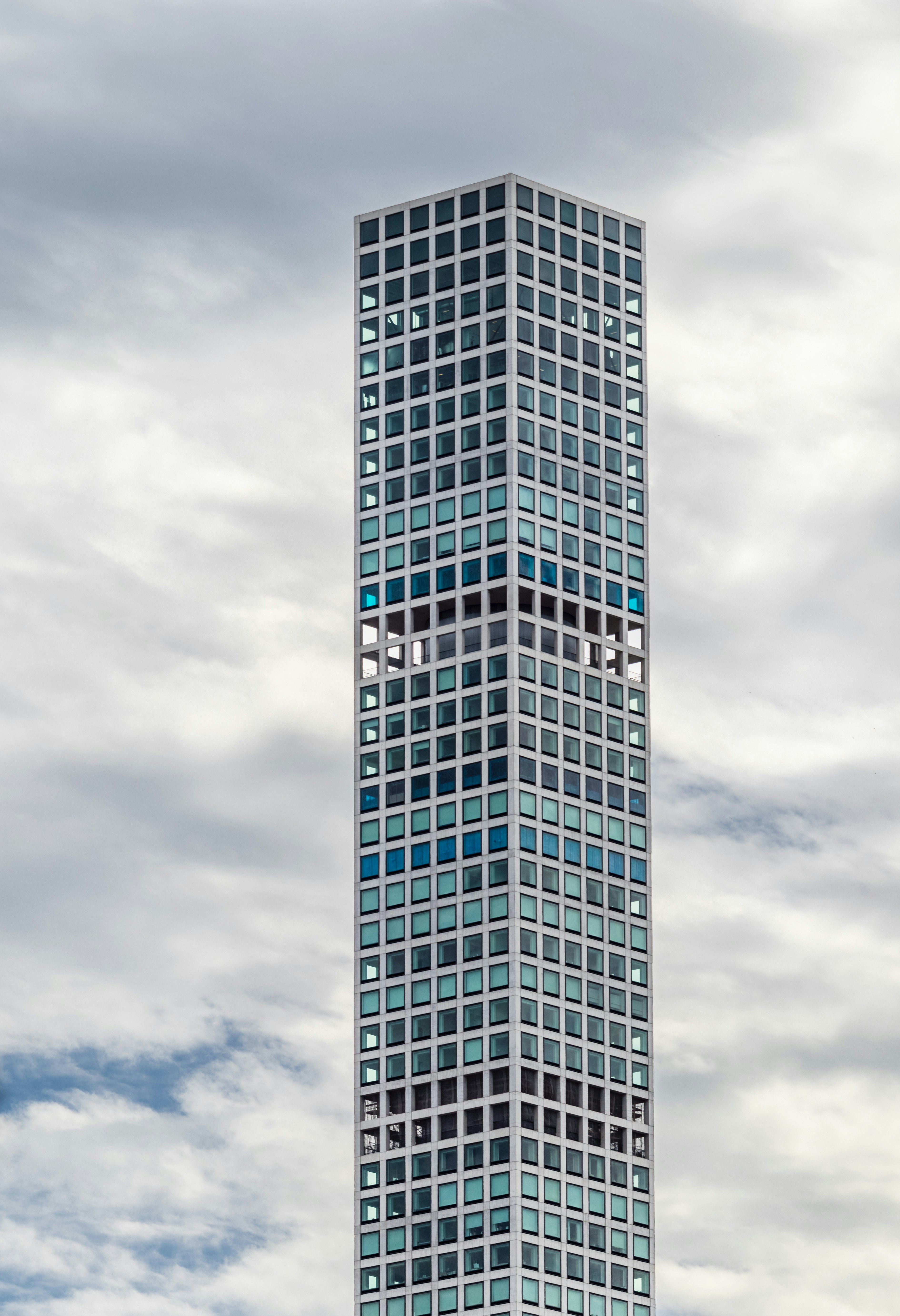 High-rise mirror building under white clouds photo – Free Grey Image on ...