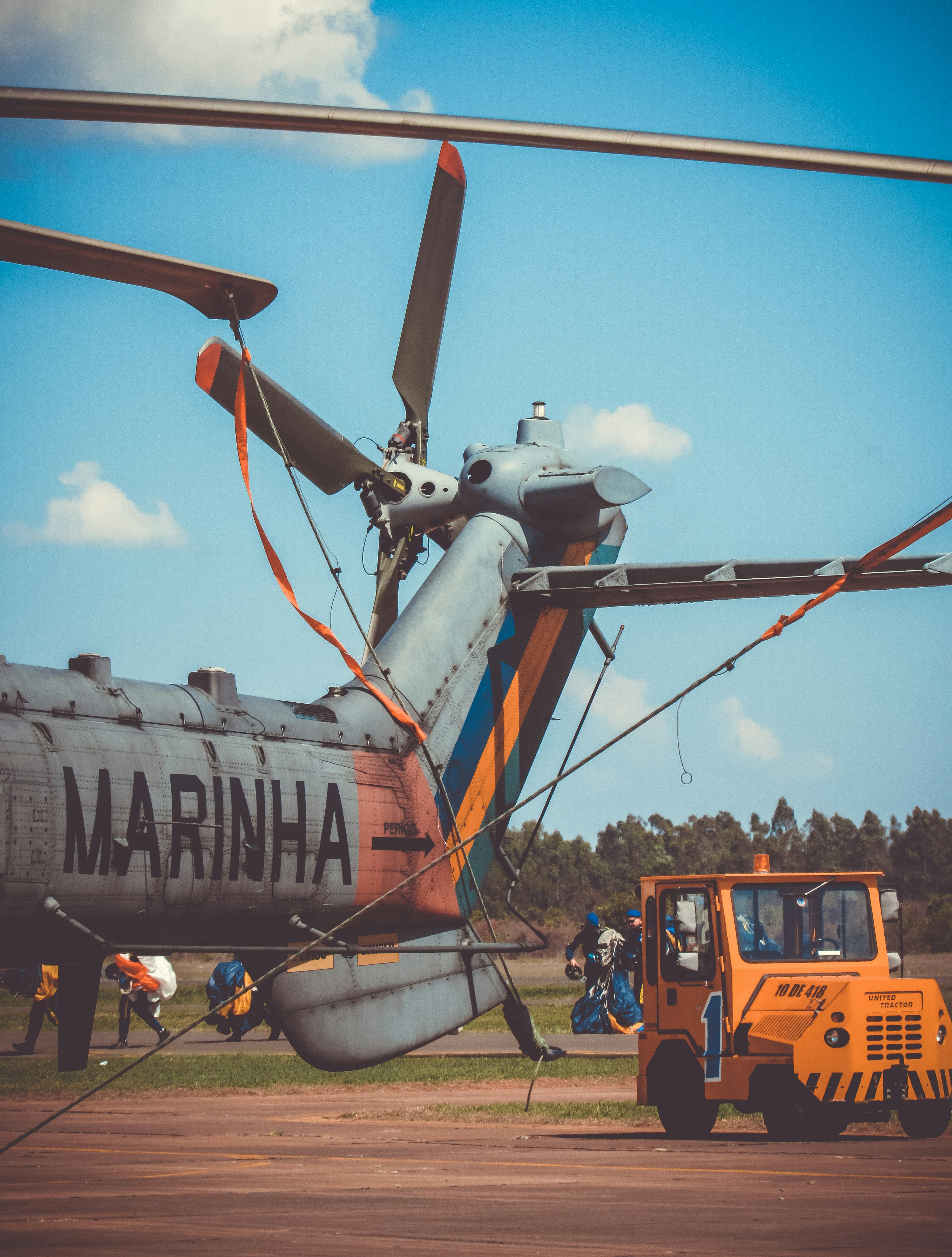 Helicopter on the Tarmac: Ground Crew and Tug in Action