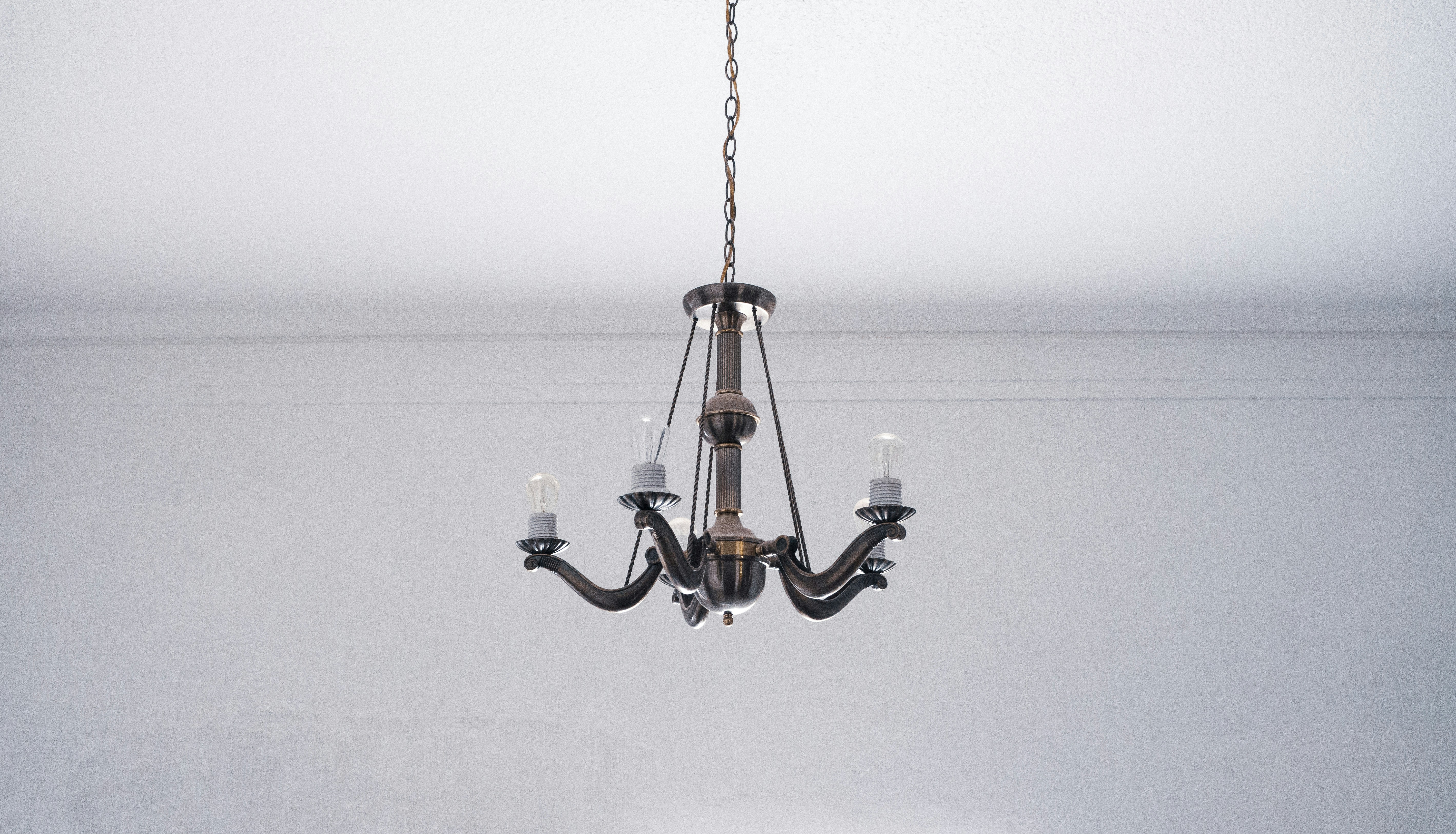 Midair Grace: a Vintage Chandelier in a Whisper-White StudioSayo Garcia
