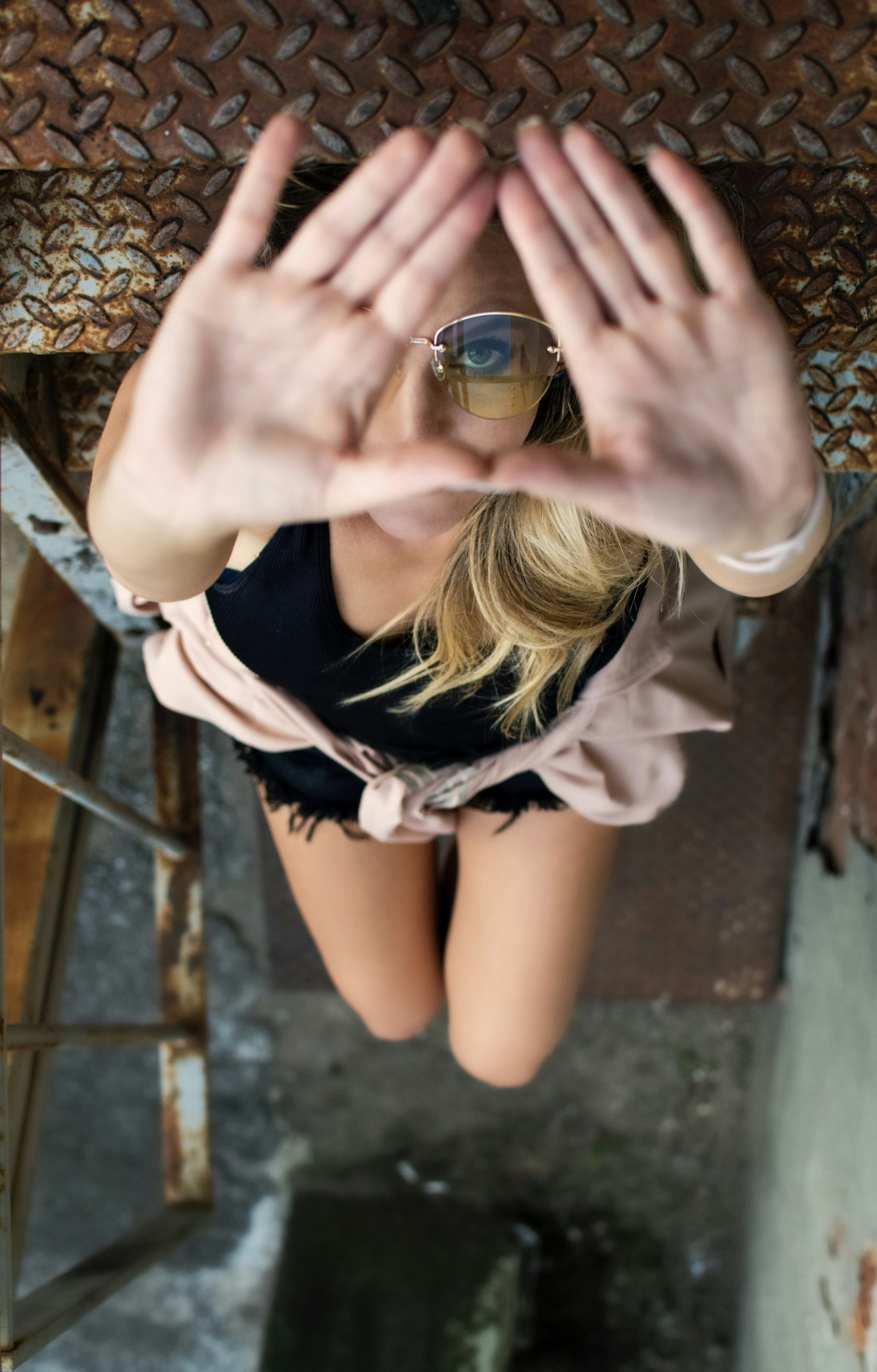 Glimpse Through a Triangular Frame: Portrait Peering Up from Rusted Steps