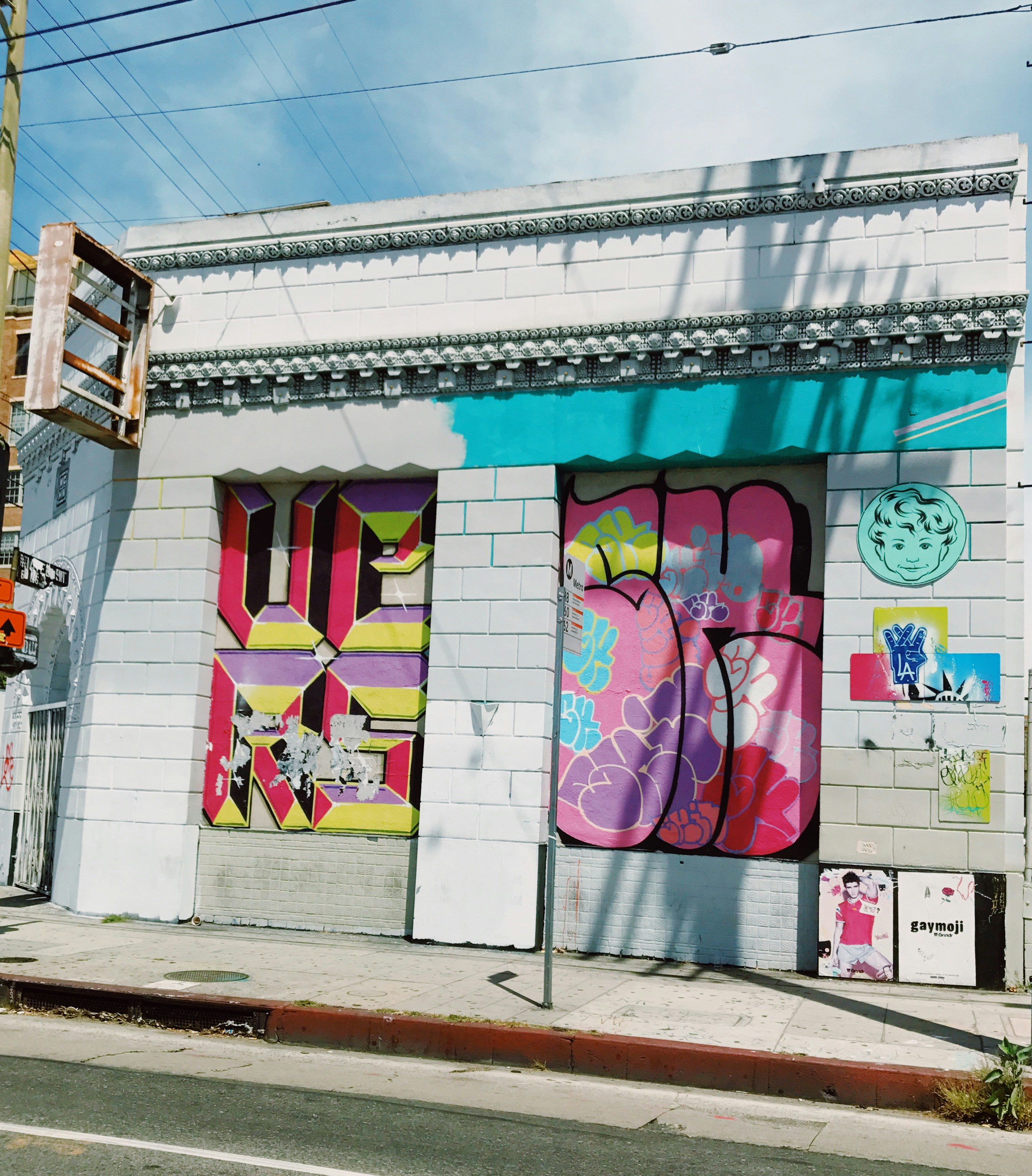 Urban mural doorway: a splash of color under a bright teal awning