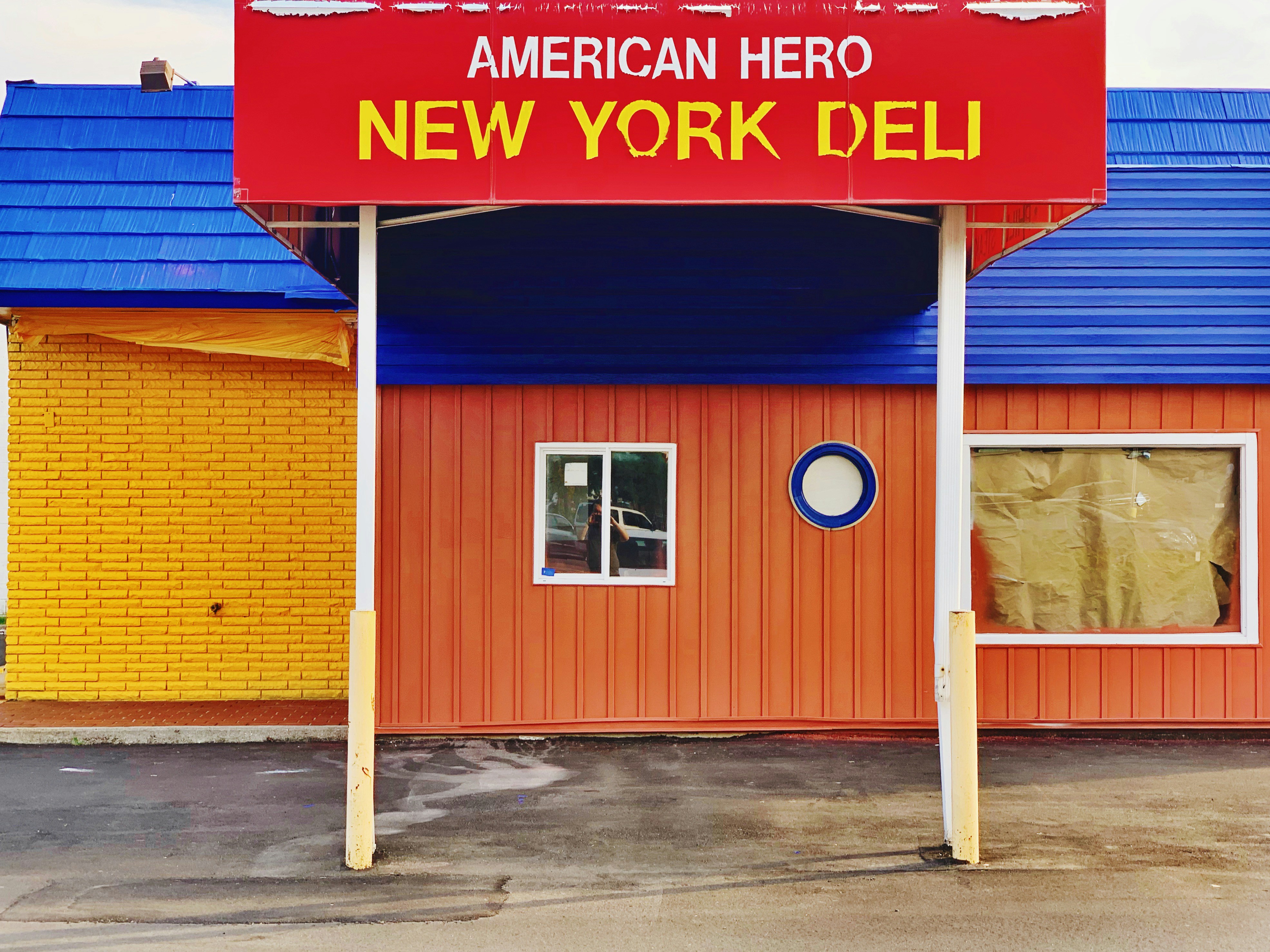 Color-Block Corner Deli Under a Bold Red Sign