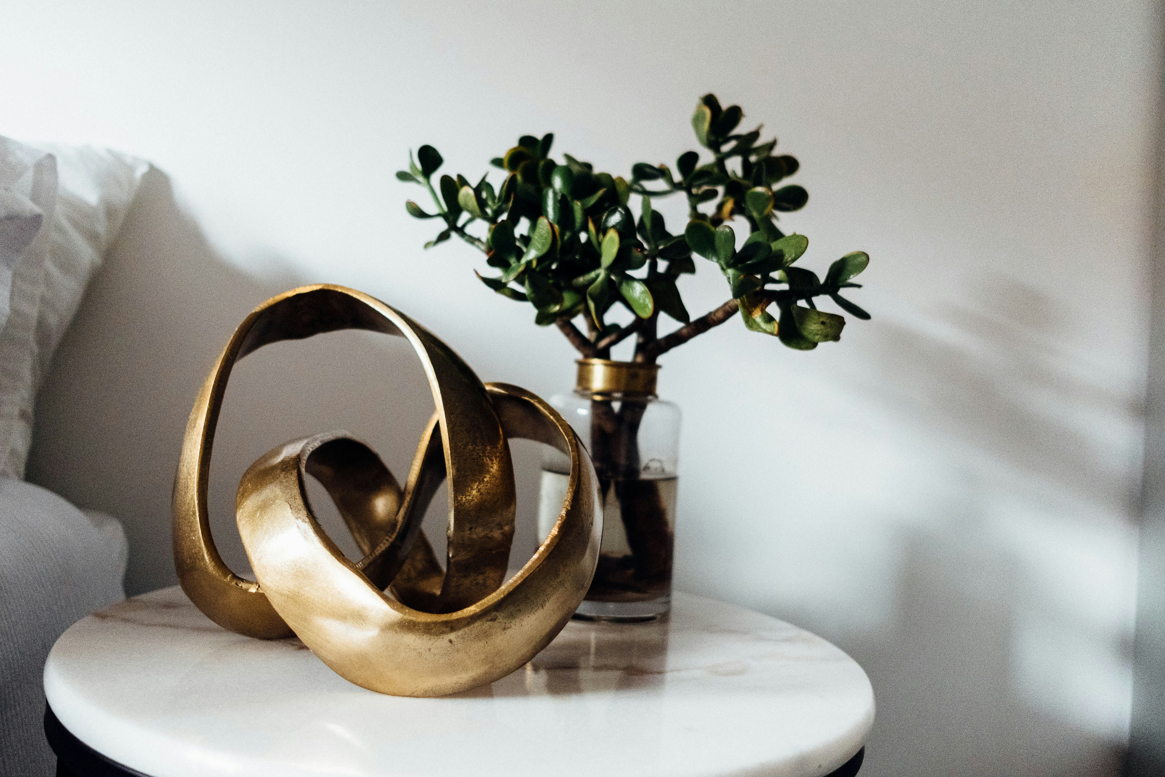 Orbital Quiet: Gold Sculpture Framing a Marble Moment