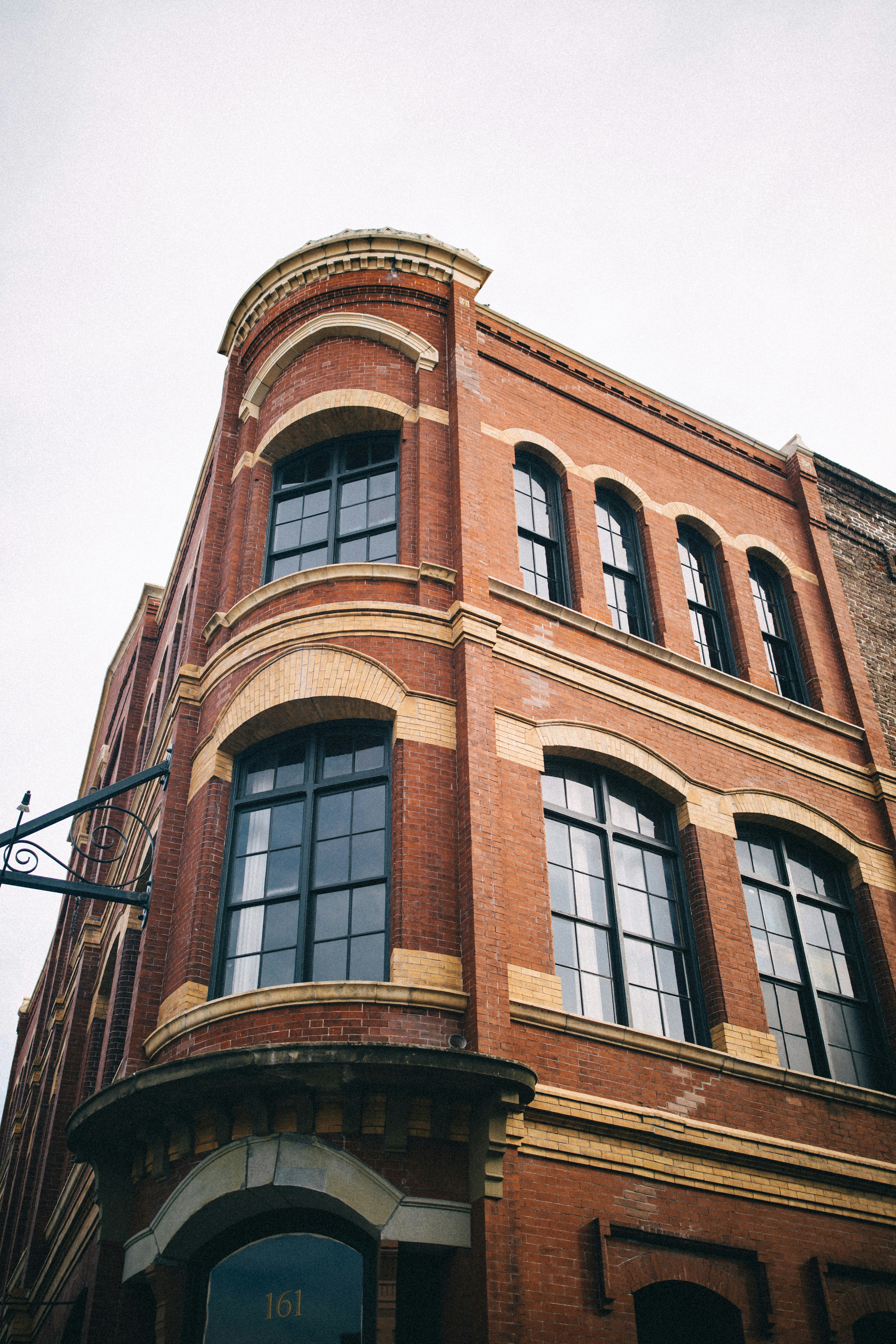 Historic brick building with arched windows and intricate detailing, showcasing classic architectural design.
