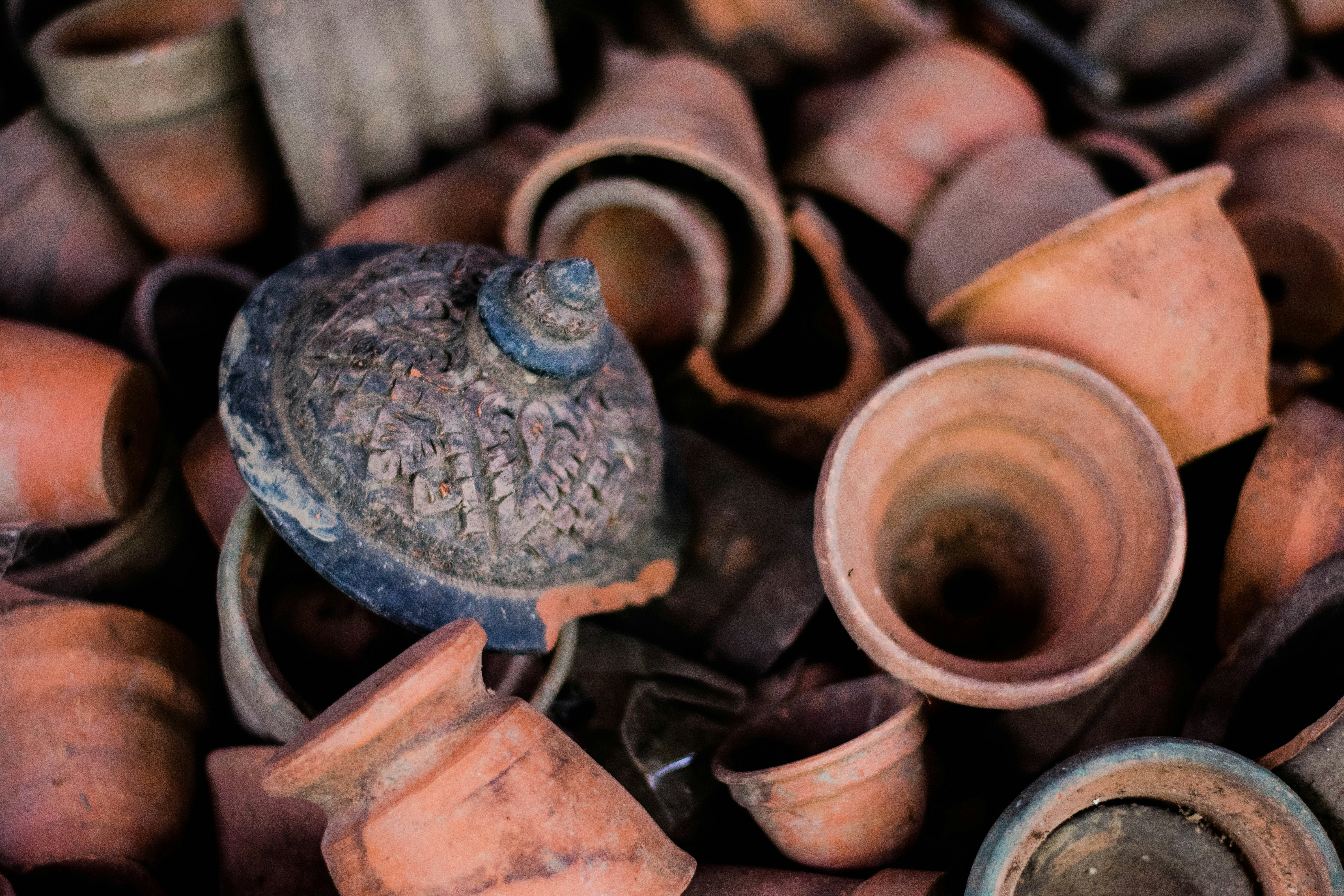 A collection of weathered clay pots and fragments with varying textures and colors.