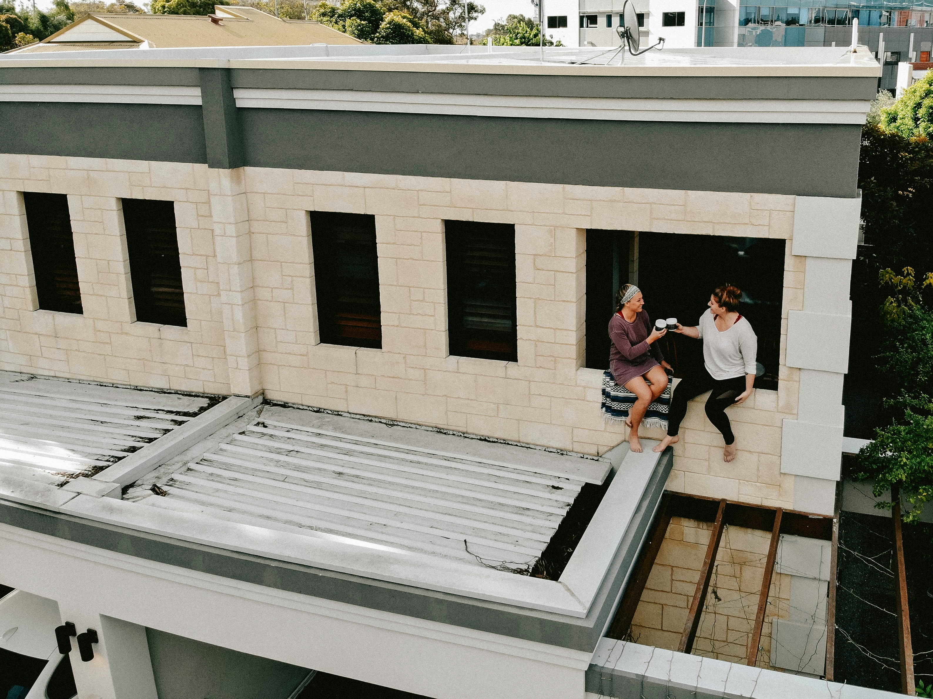 Roofside Chat Above the Cityscape