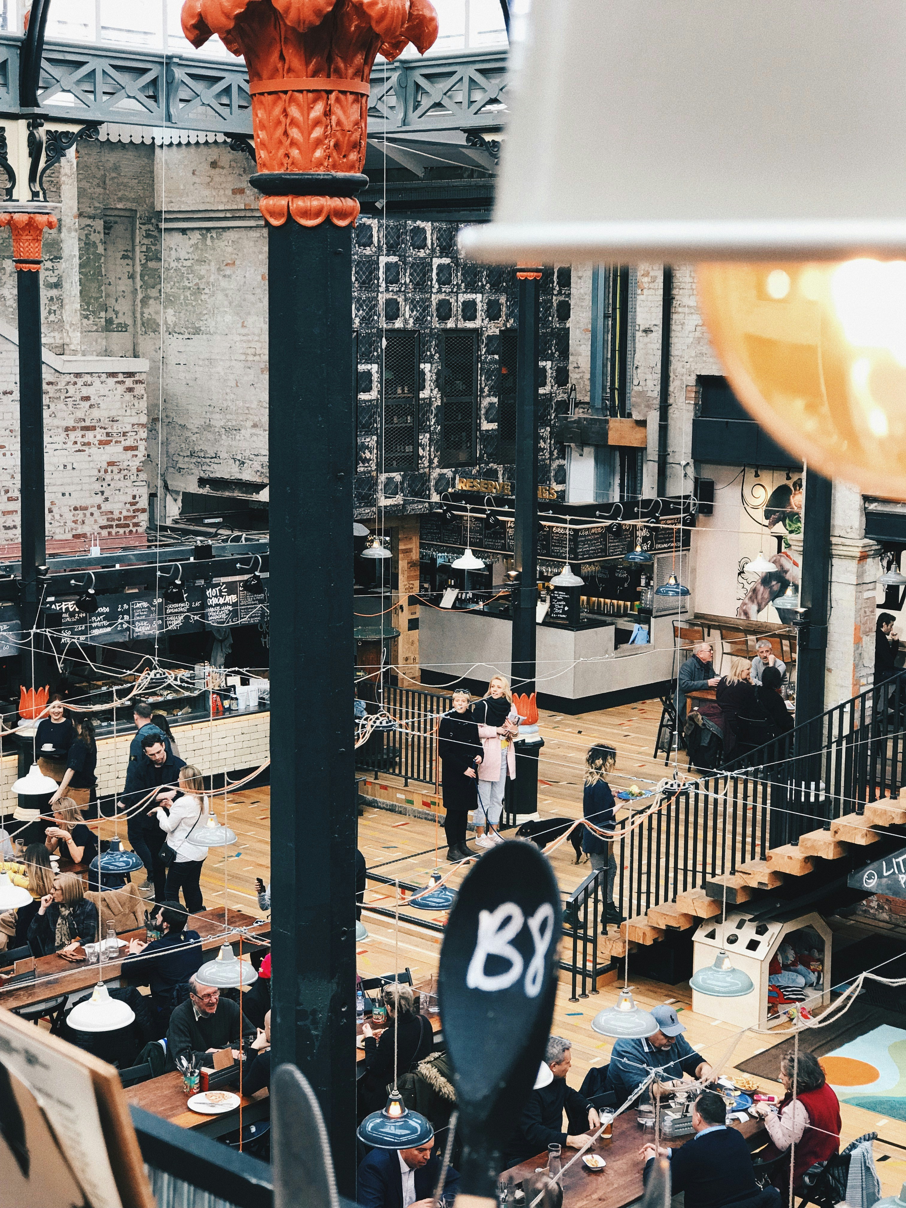 Industrial loft party: a bustling venue with elevated view and hanging lamps