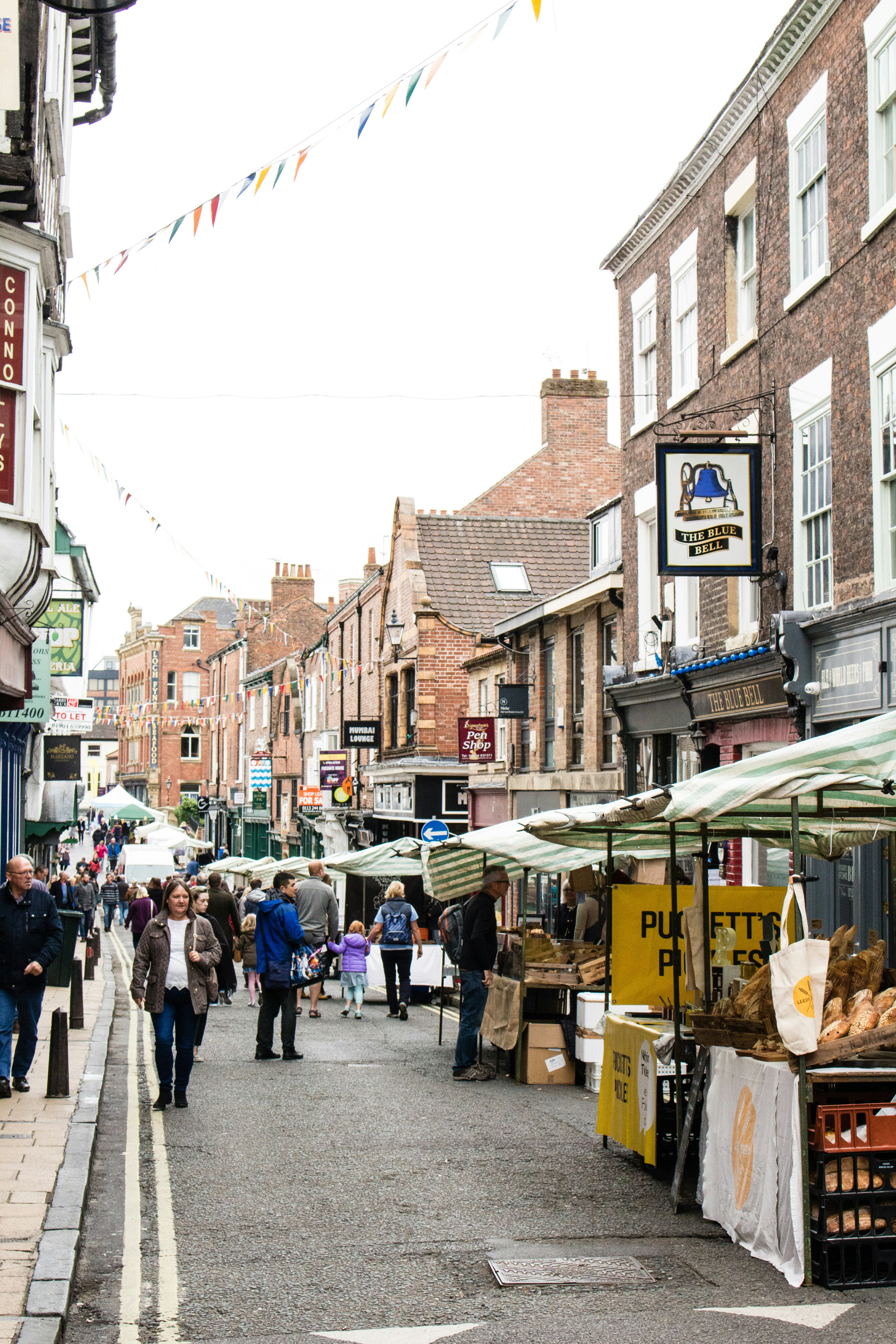 Bunting and Banter Along a Brick-Lined Market Street