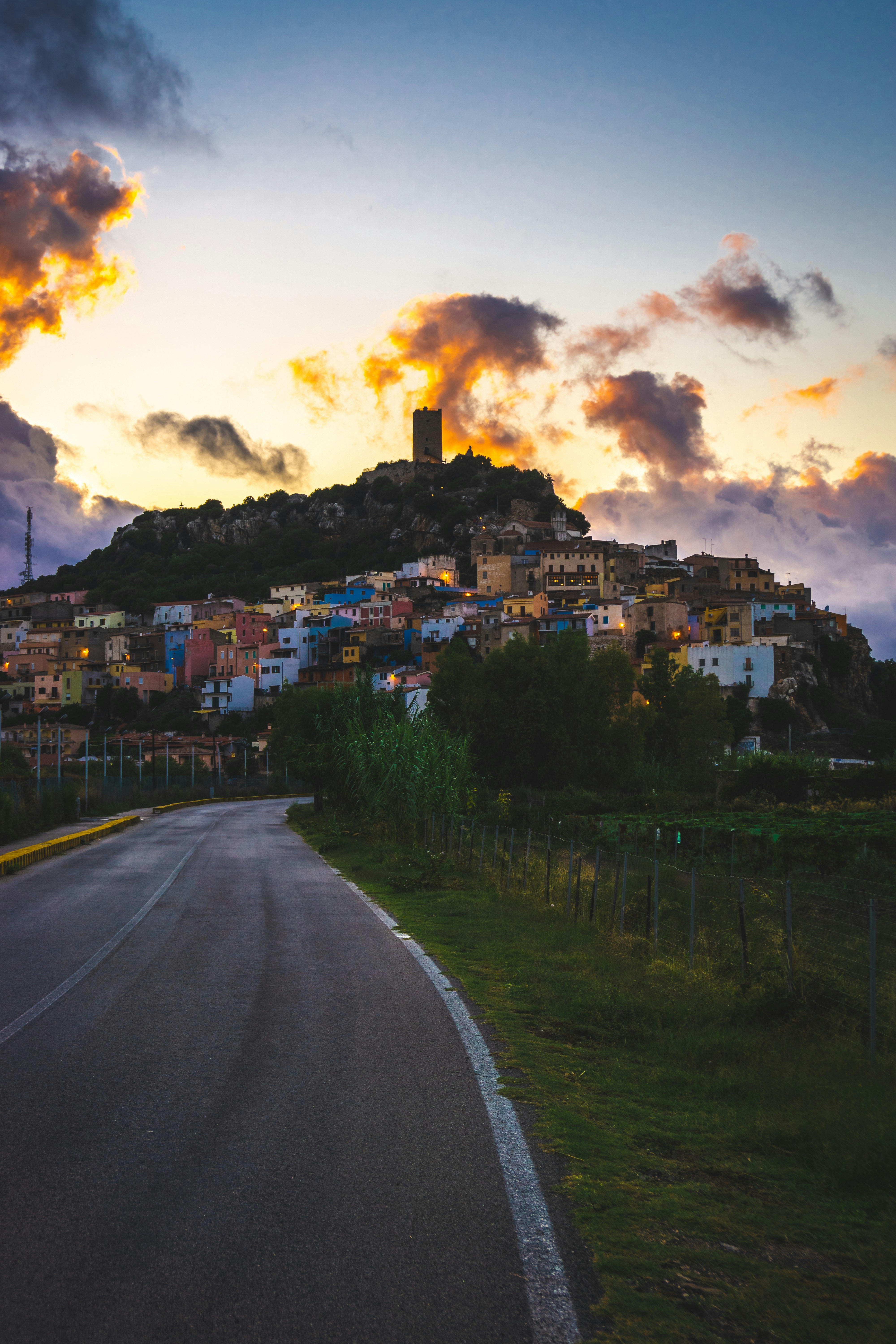 Dusk Over the Hill Town: Tower Silhouette Against Fiery Clouds