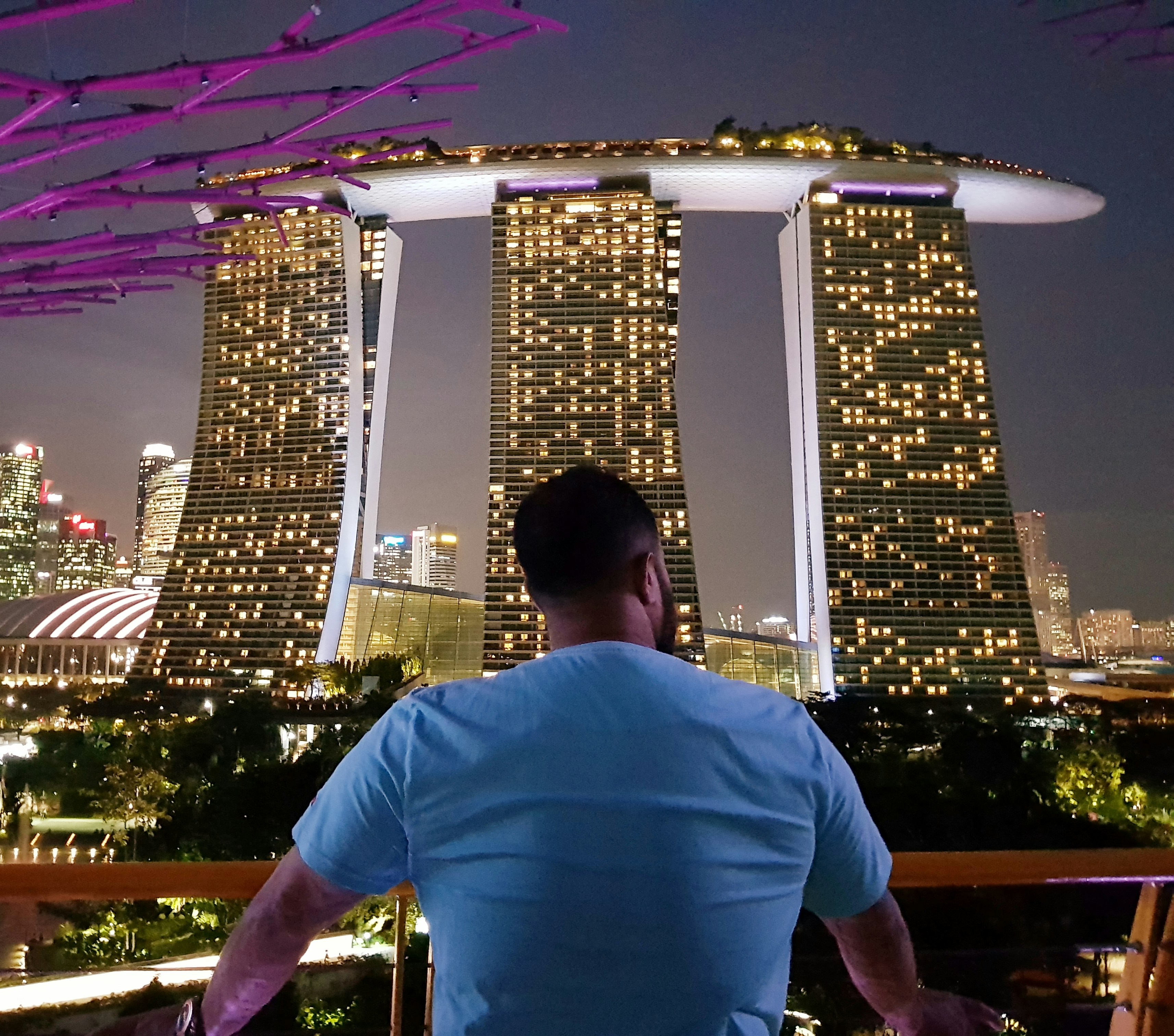 Man watching high-rise buildings at nighttime photo – Free Human Image ...