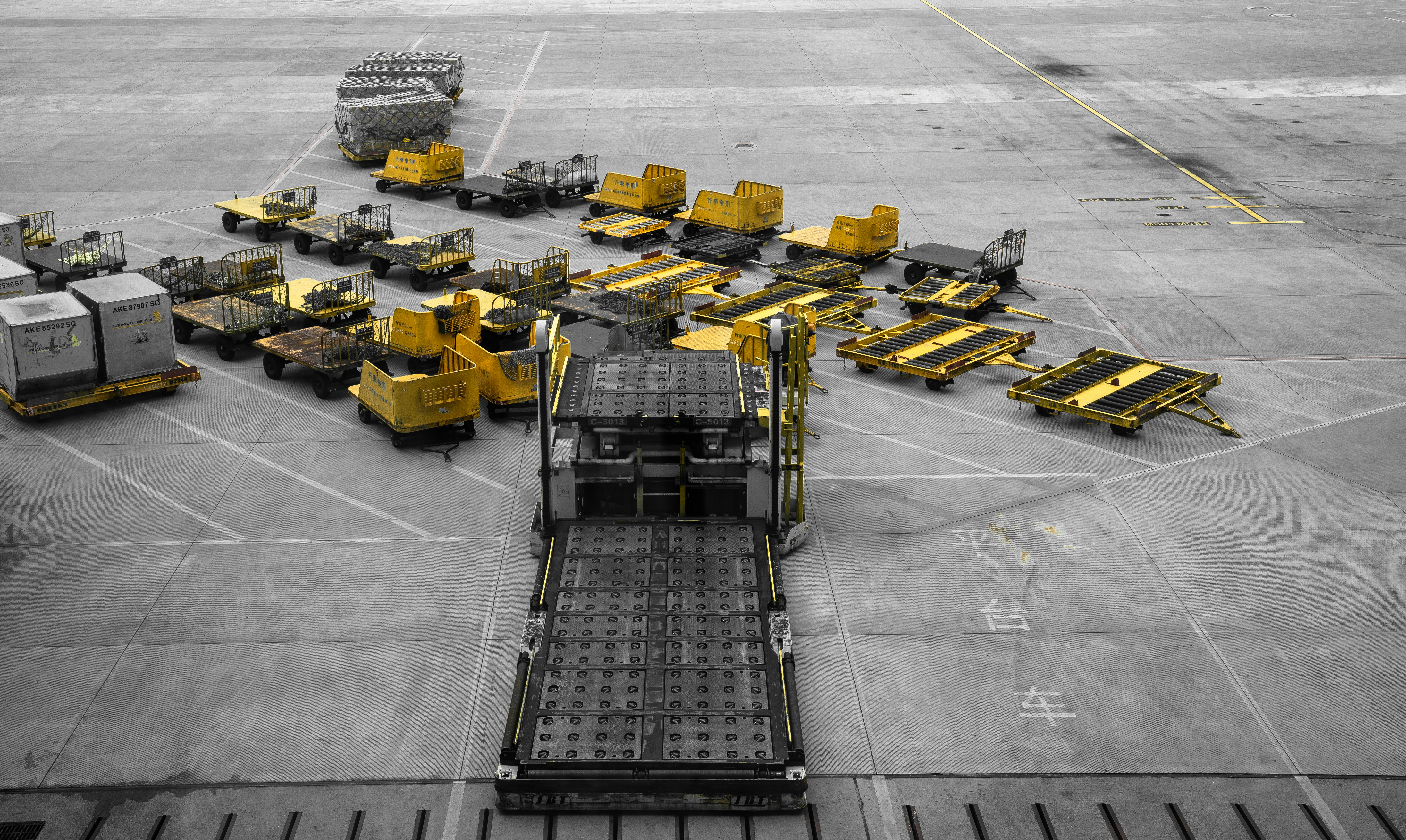 Yellow Ground Support Machinery Arranged Around a Central Ramp on the Tarmac