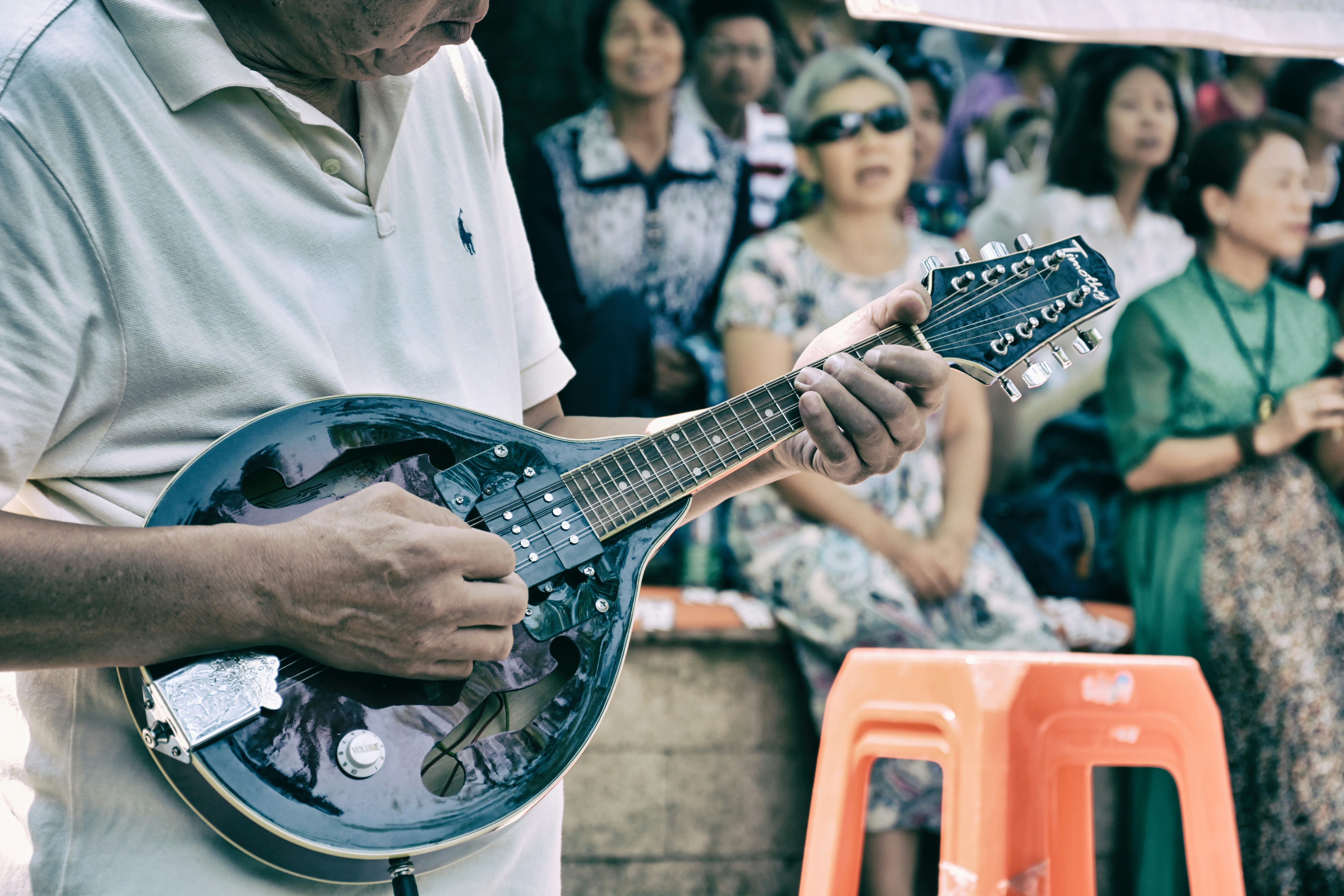 Man playing string instrument near croud photo – Free Human Image on ...