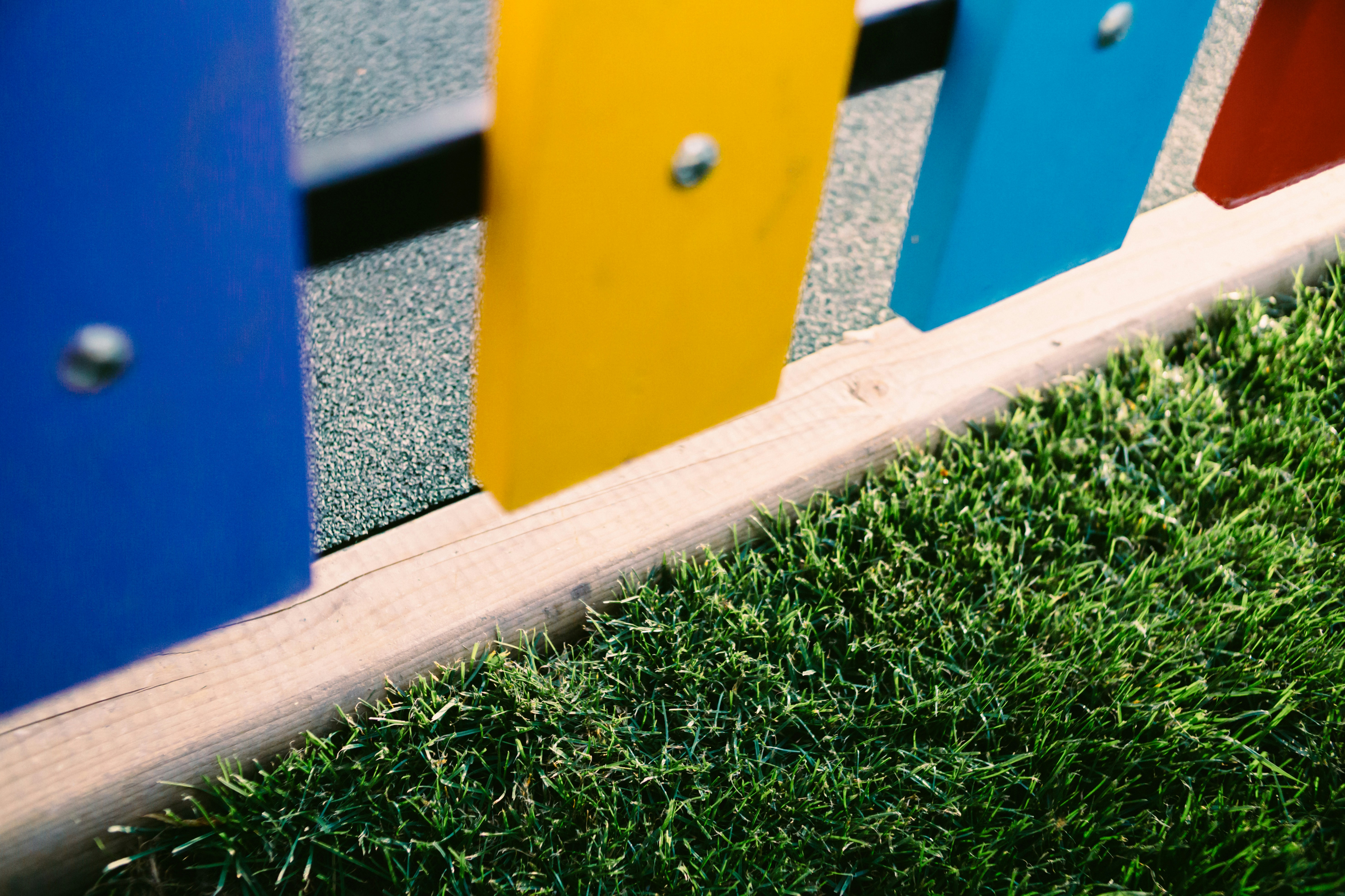 Colorful Playground Rails Framing a Patch of Green
