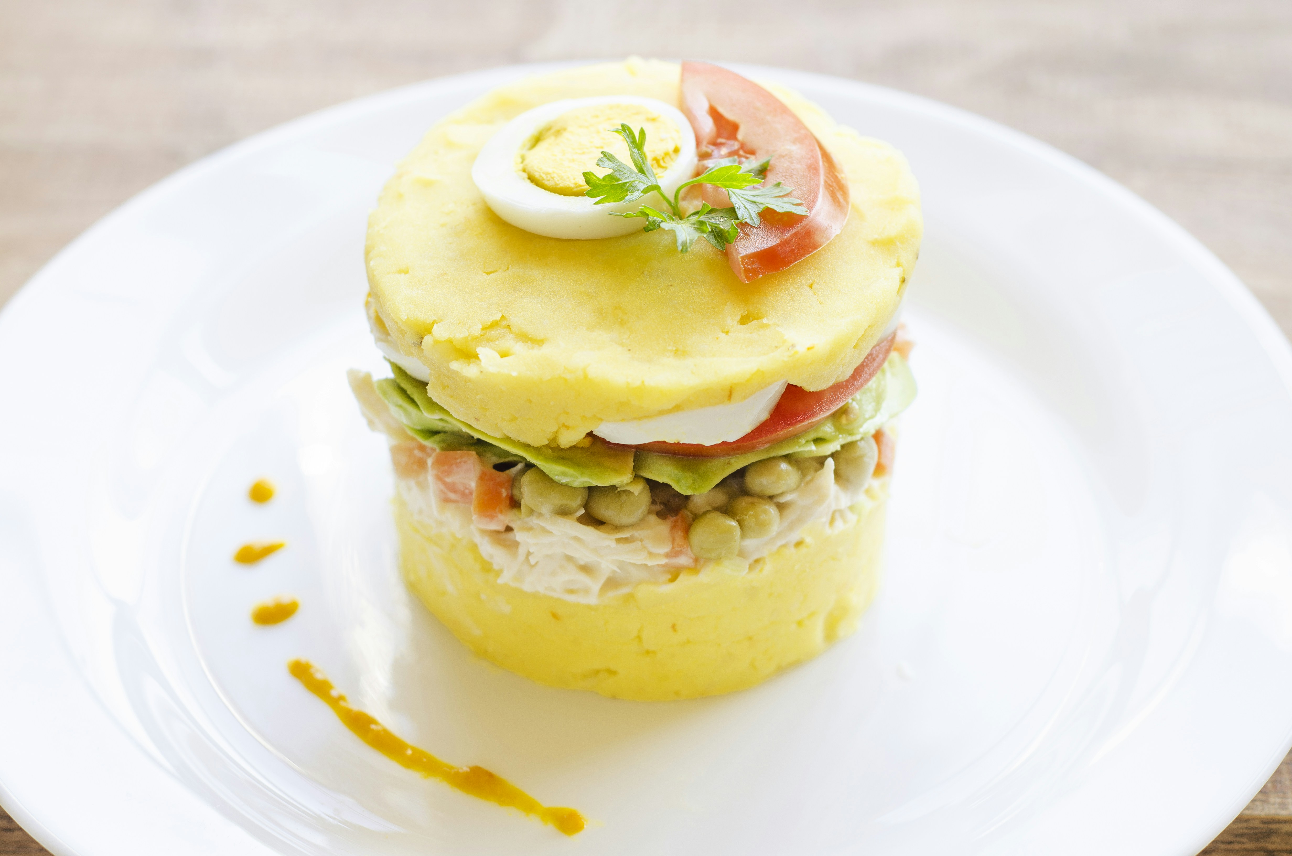 Layered Savory Tower: Chickpea Molded Delight with Fresh Garnish