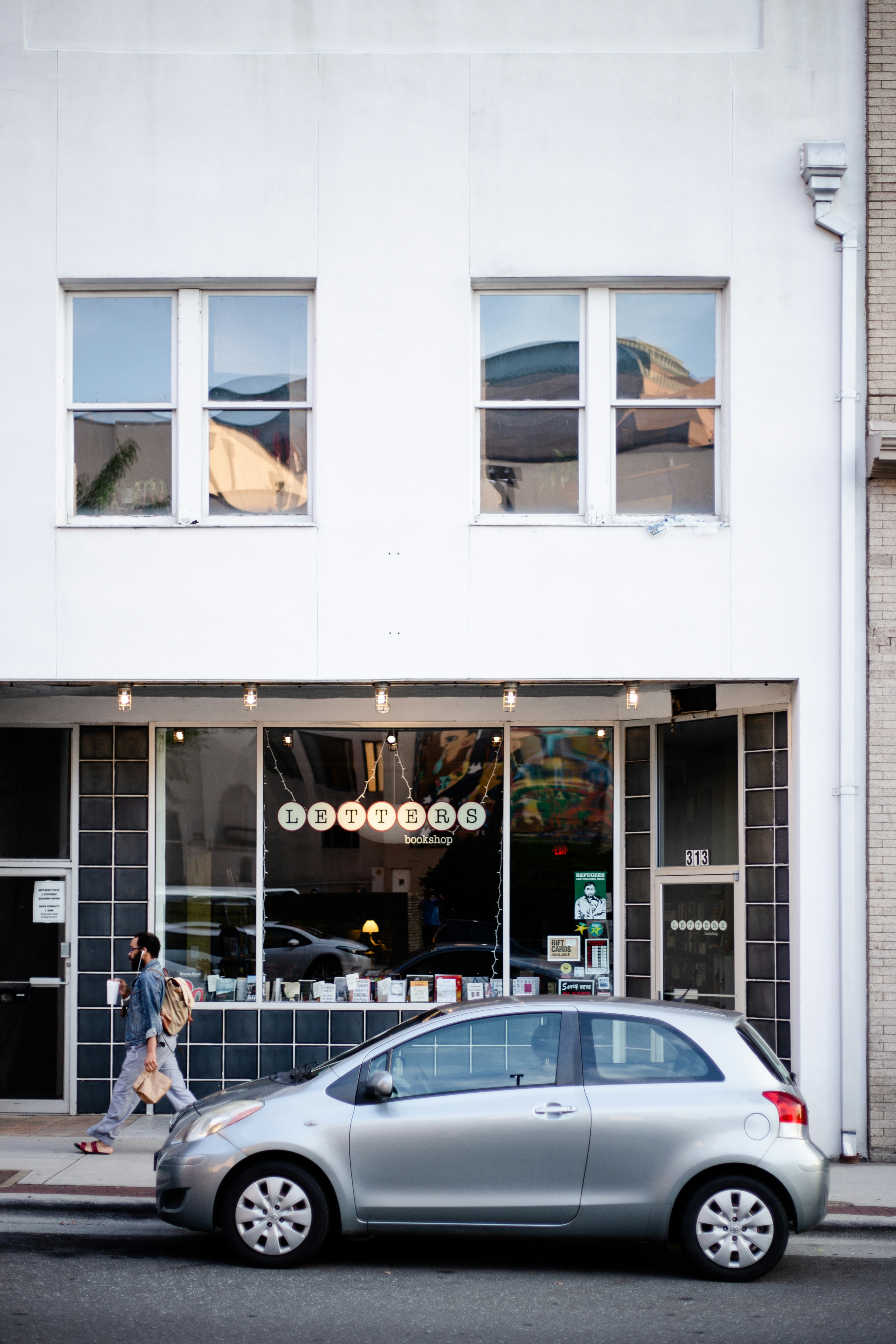 Reflections and storefronts: a city street scene in motion