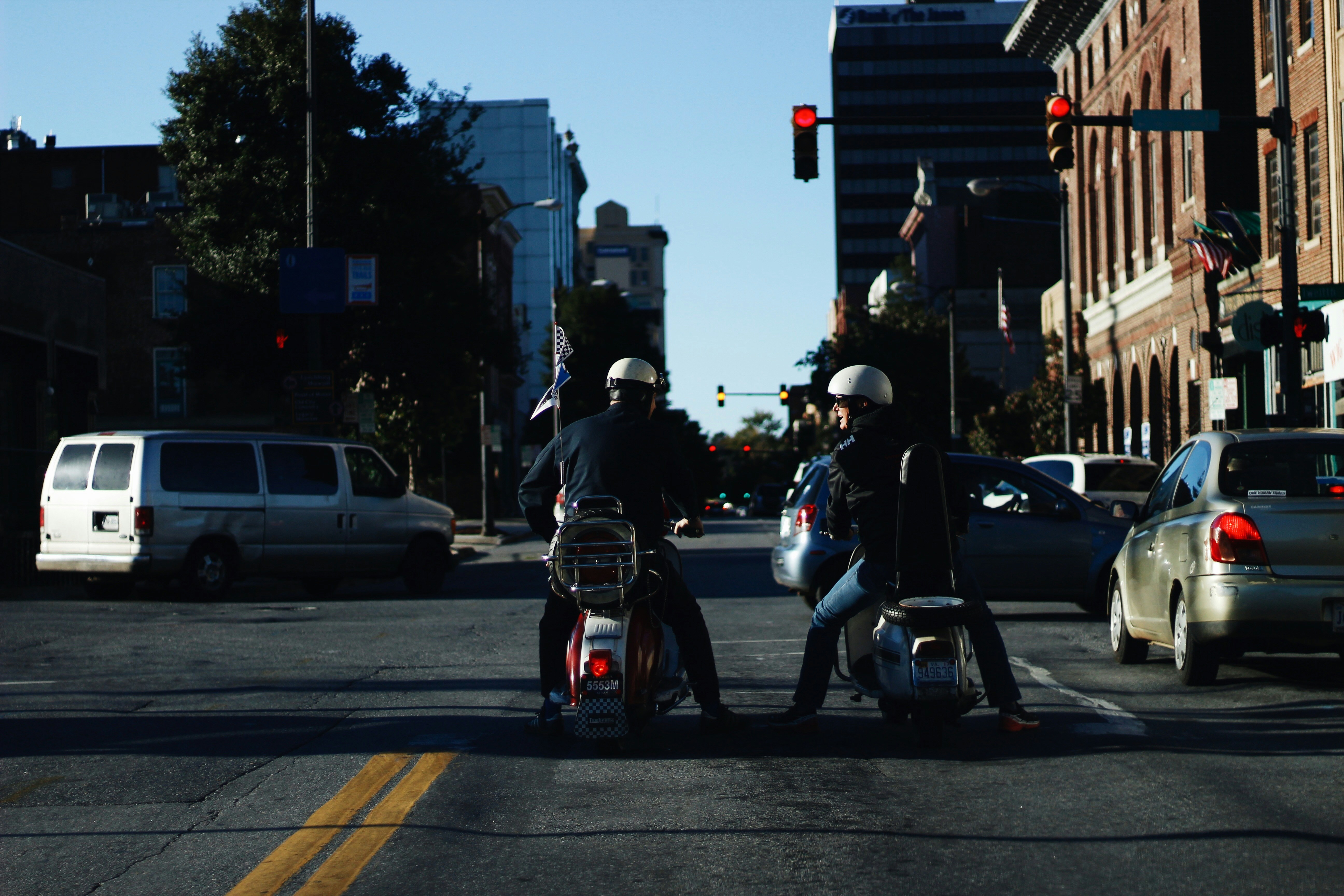 Two men riding motorcycles stop on red light on street photo – Free Car ...
