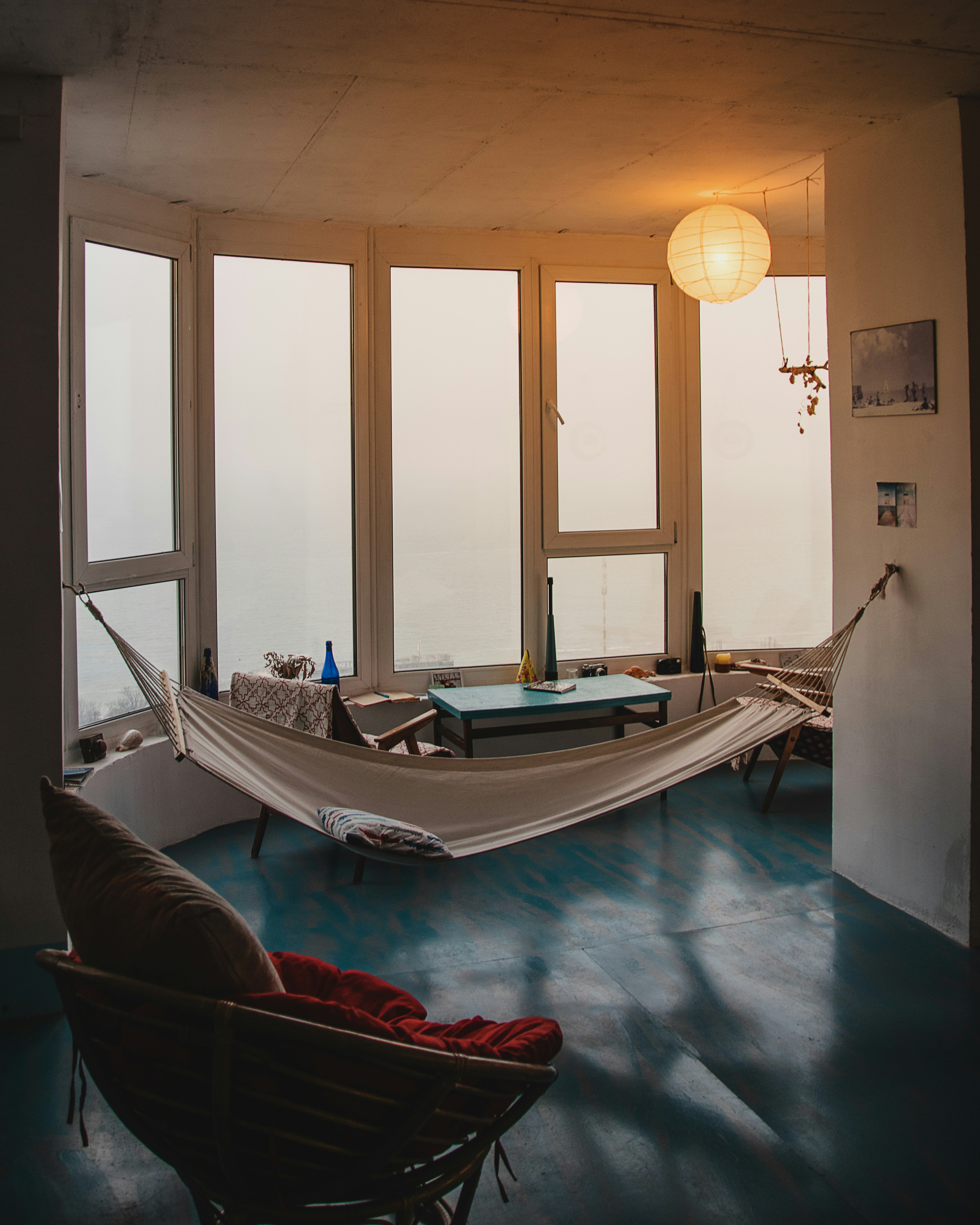 Hammock Haven: Sunlit Lounge Framed by Paned Windows