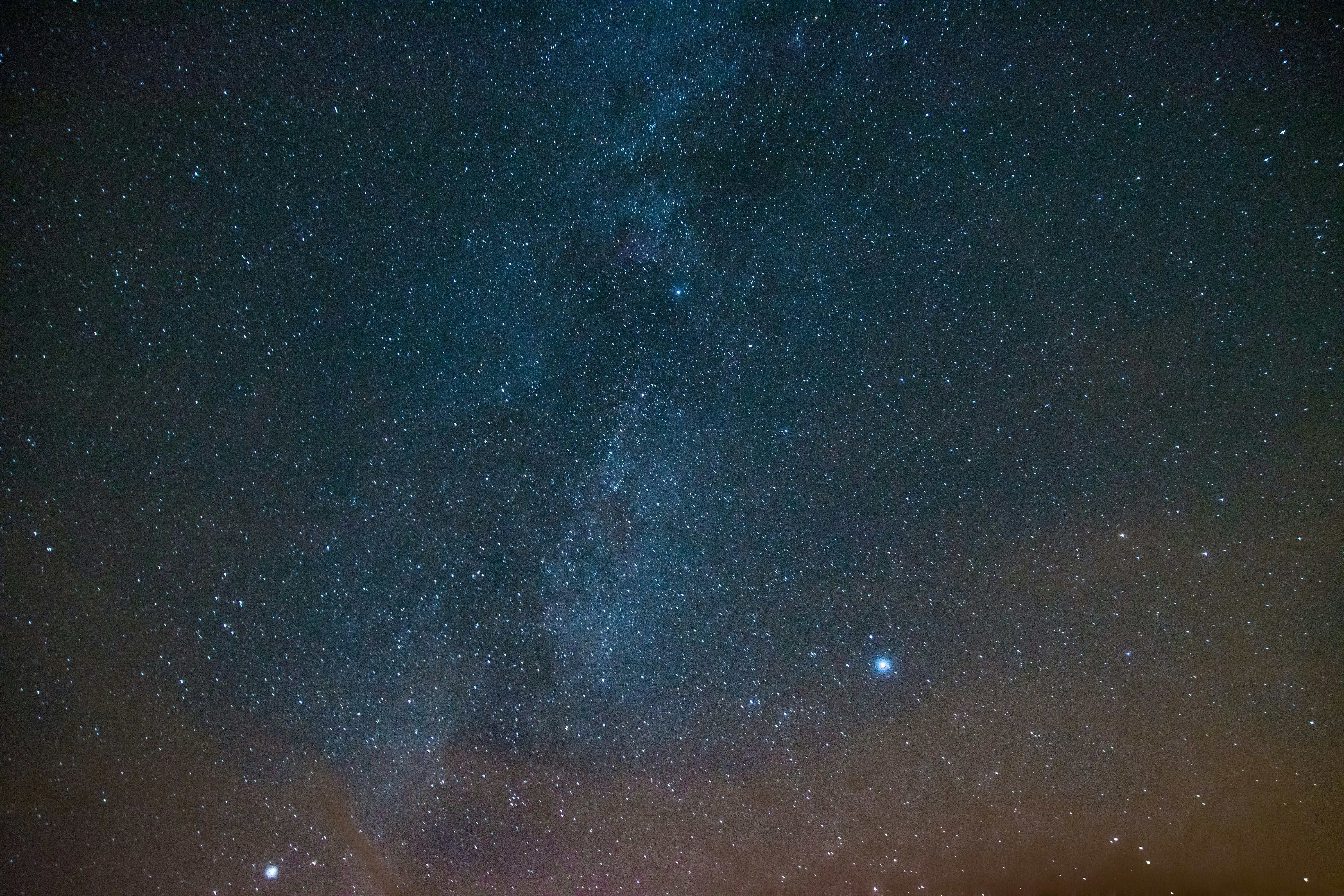 Star-filled night sky with the Milky Way stretching across the darkness.