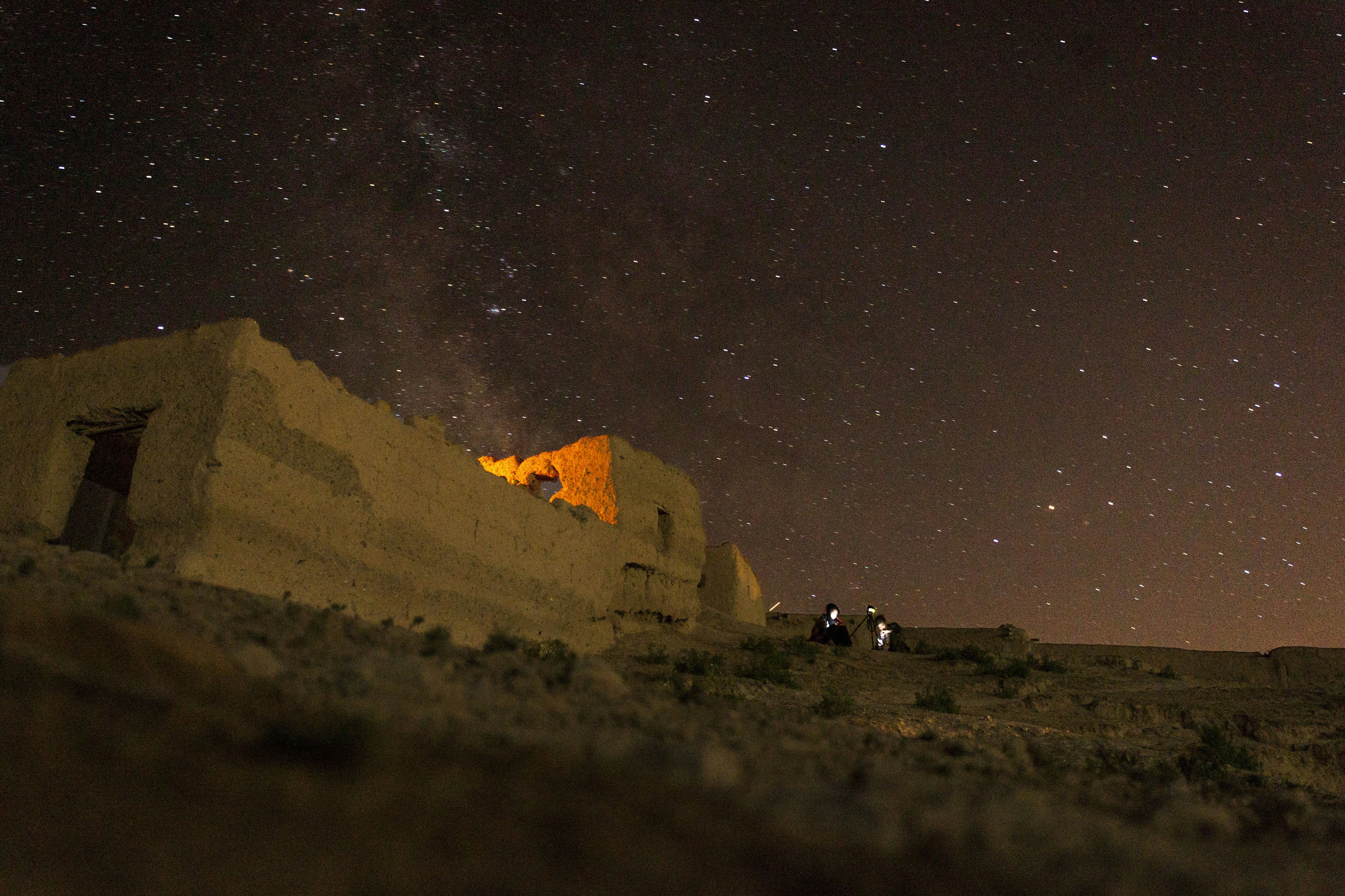 Glow on the Ruin: Starfield Over a Desert Structure