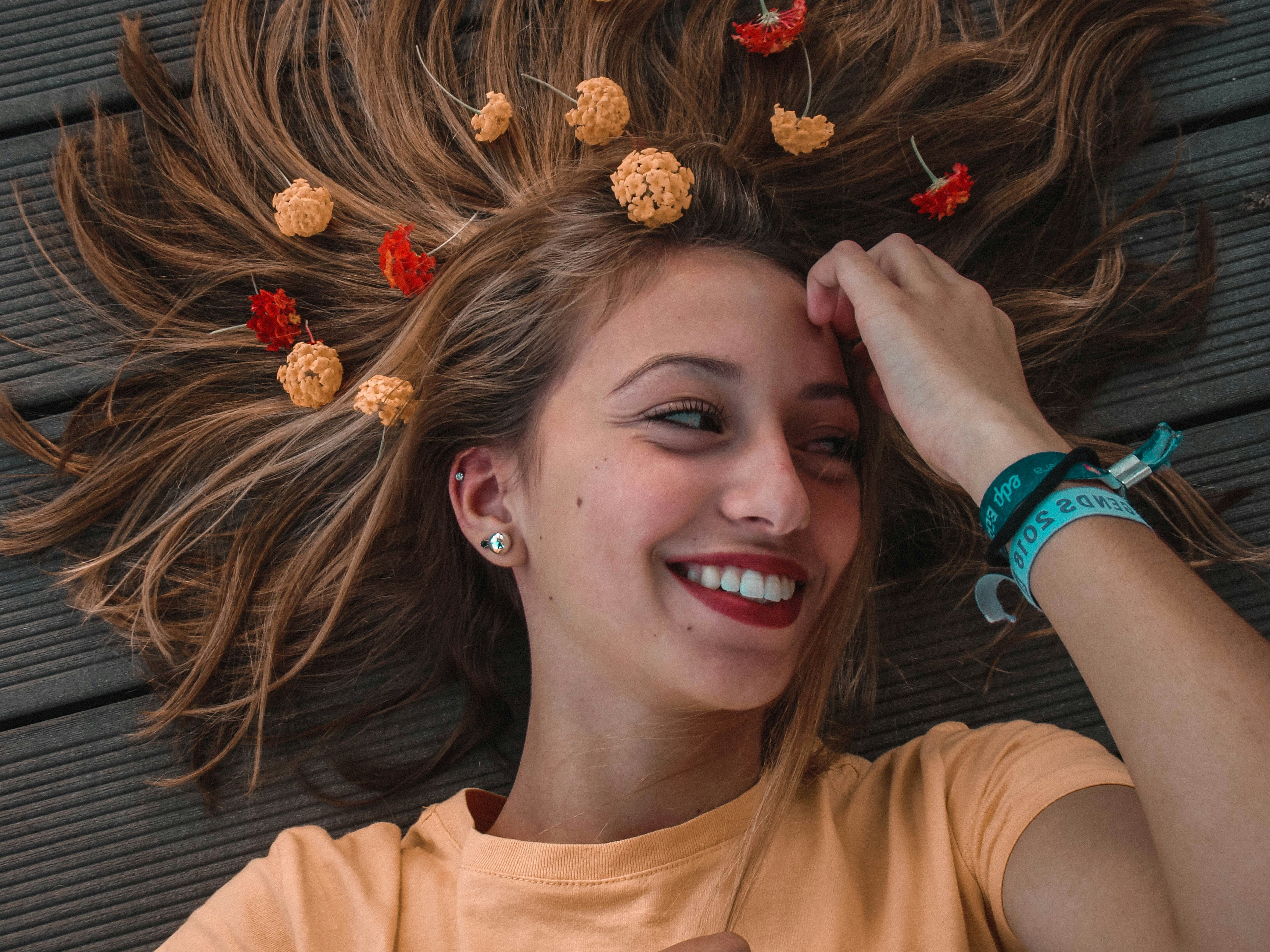 Sunlit Smile: Girl with Hair Adorned by Tiny Flowers