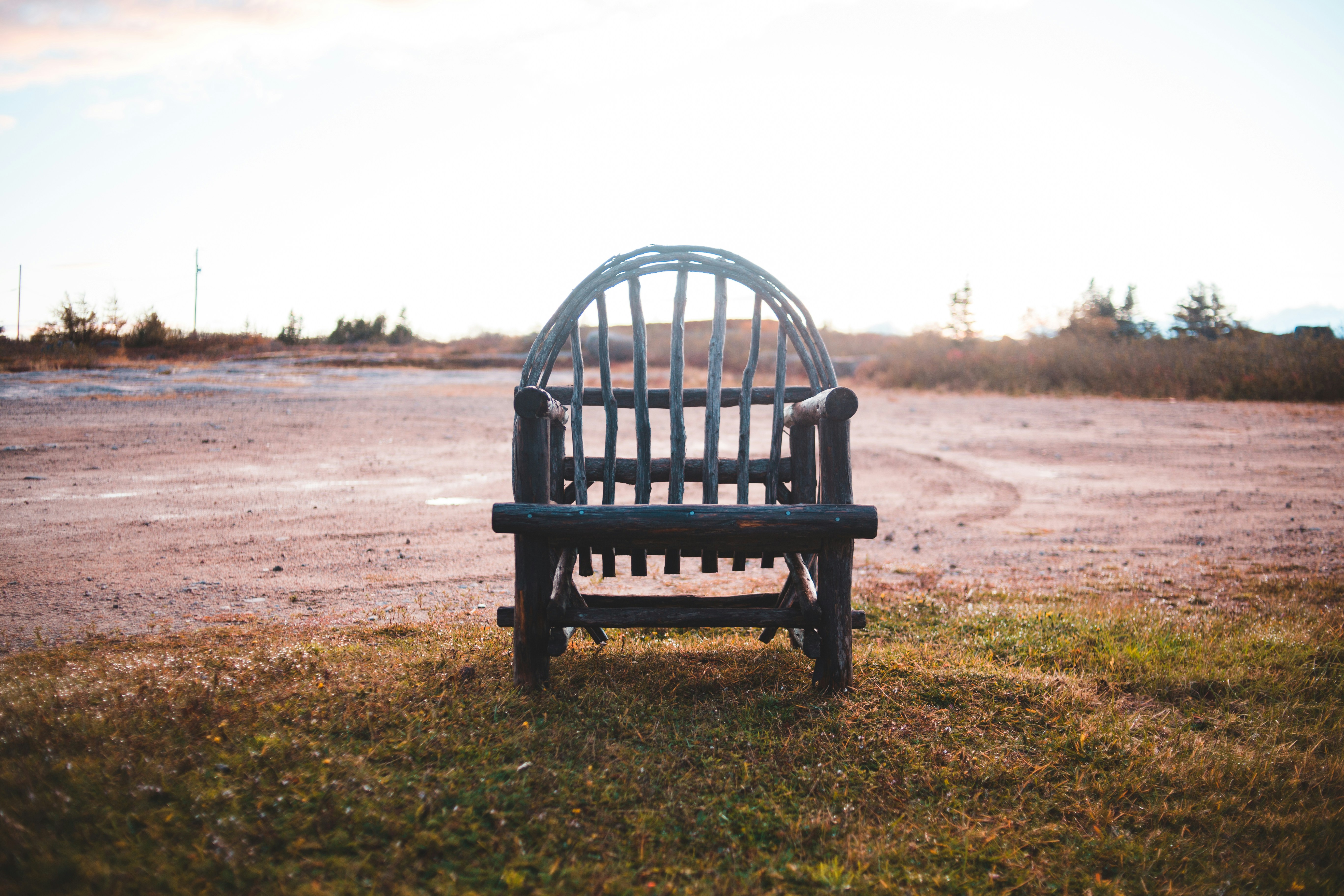 Solitary Wooden Chair on a Windswept Field
