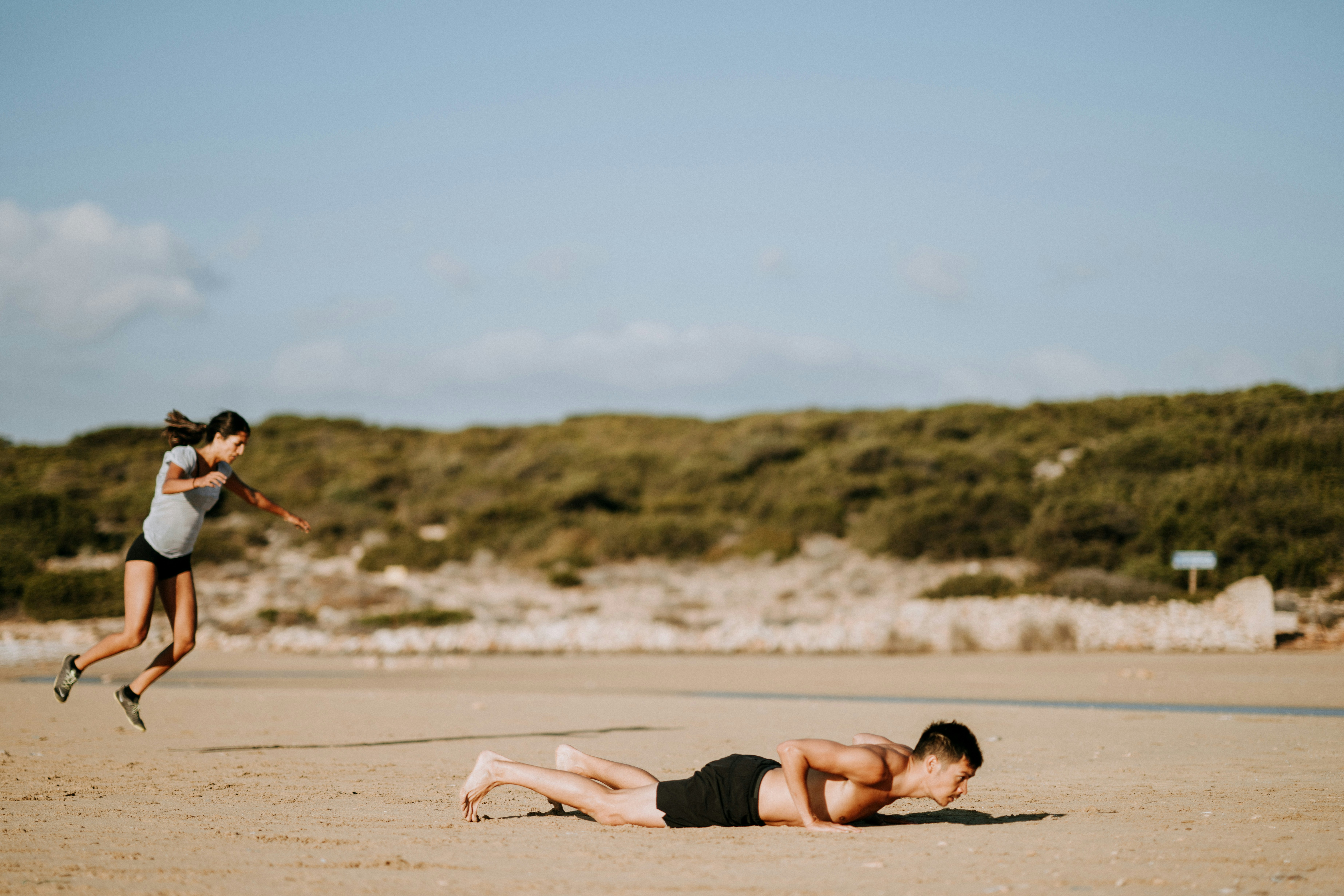 Woman jumping behind man during daytime photo – Free Person Image on ...